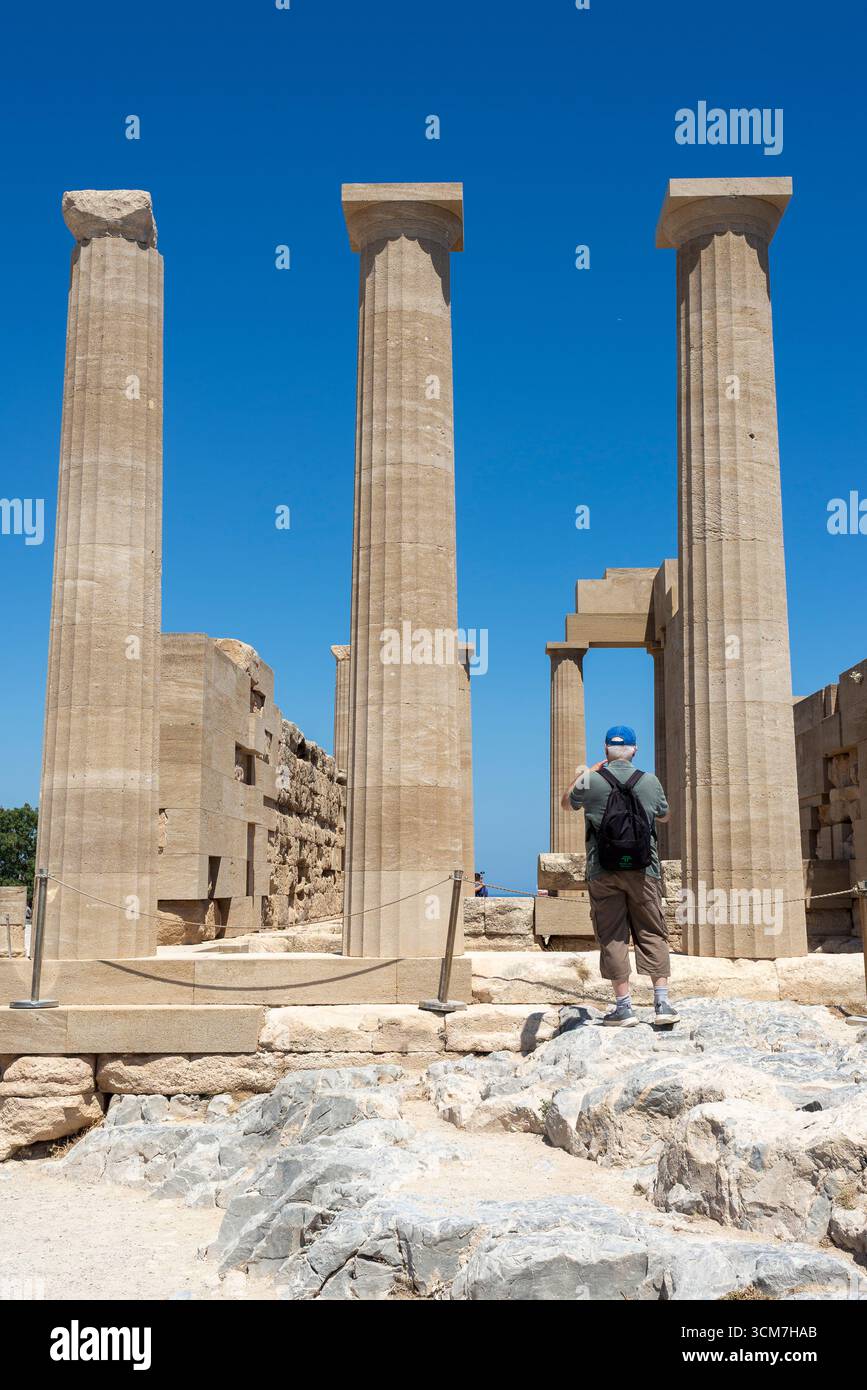 Tourist at Temple of Athena Lindia, Acropolis, Lindos, Rhodes, Greece ...