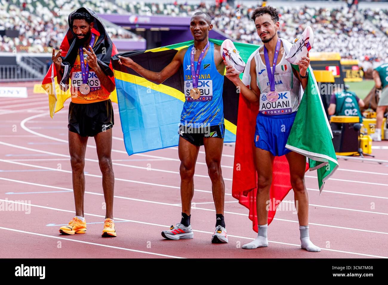 second finisher and holder of silver medal Amanal Petros of Germany and ...