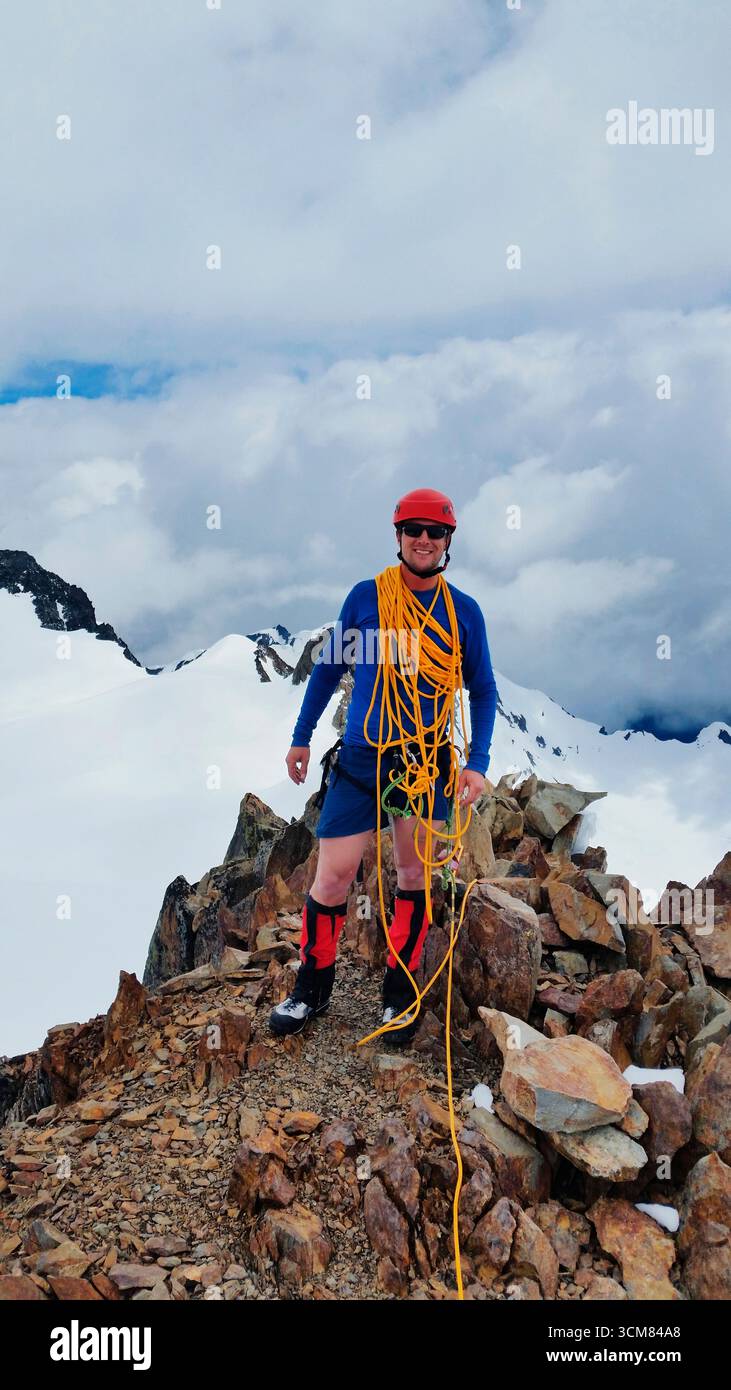 Portrait of mountain climber at summit of Mount Olympus, Washington ...