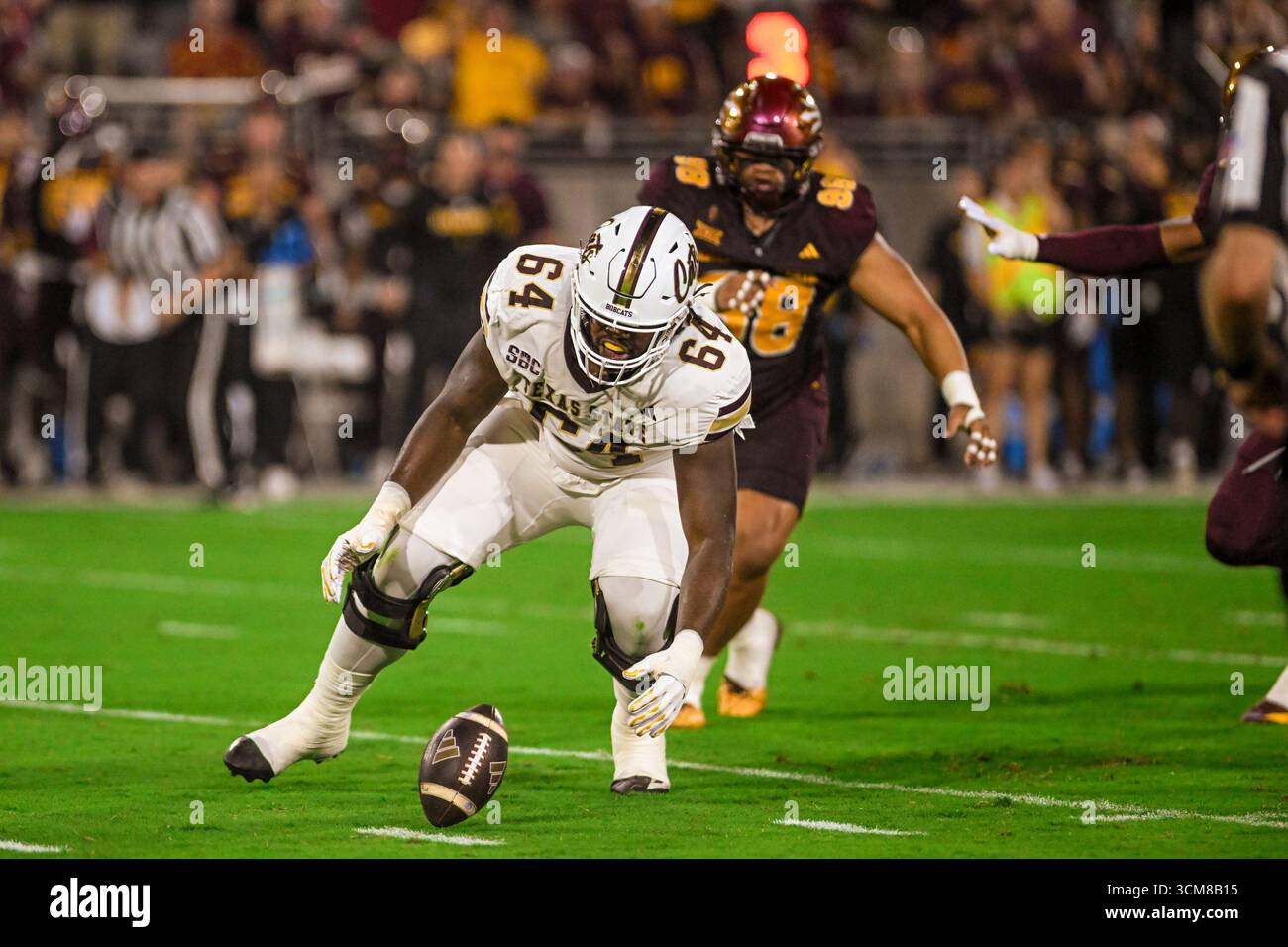 Texas State Bobcats offensive lineman Dorion Strawn (64) dives onto the ...