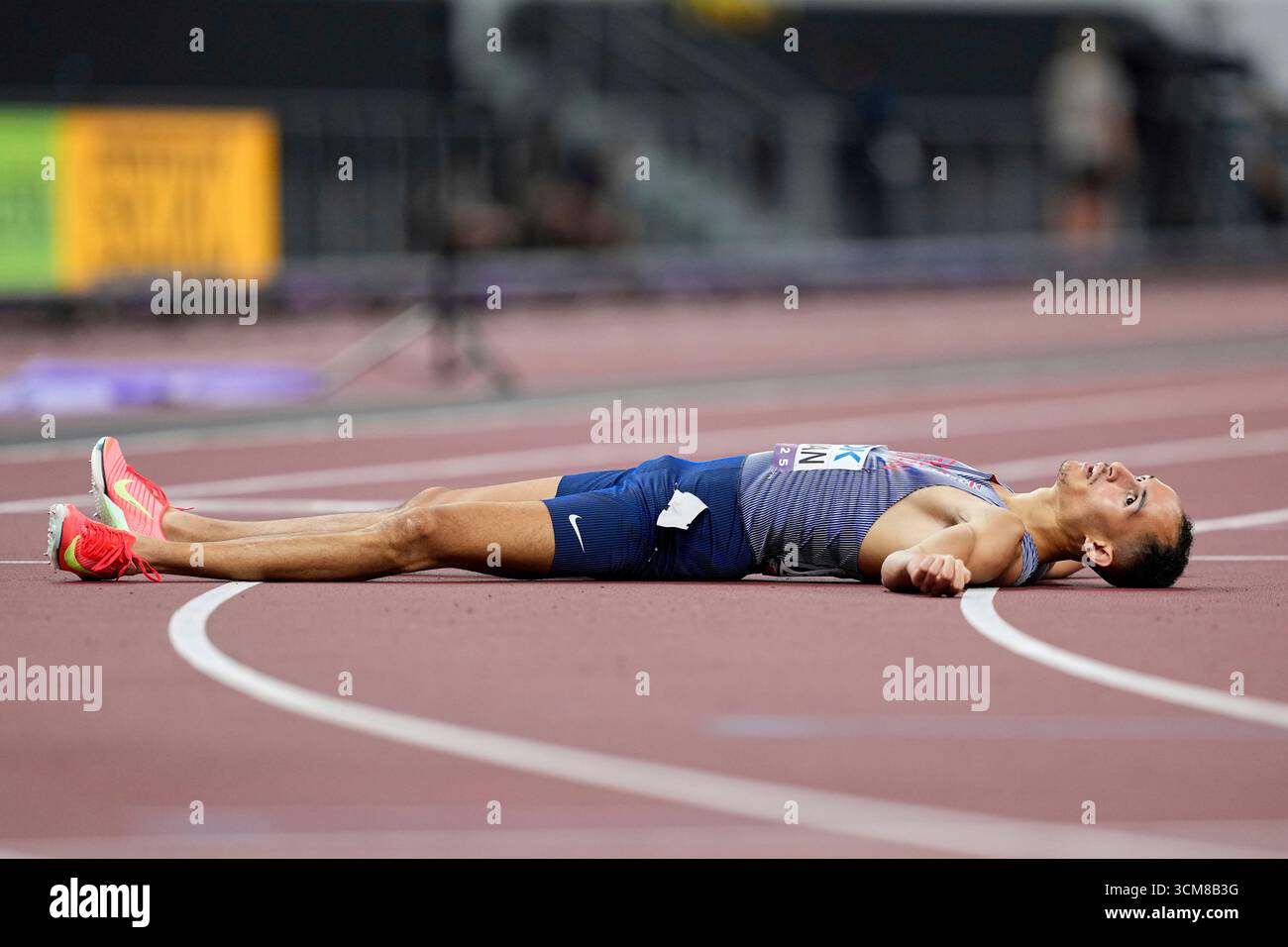 Britain's Tyri Donovan lays on the track after falling across the line in a men's 400 meters ...