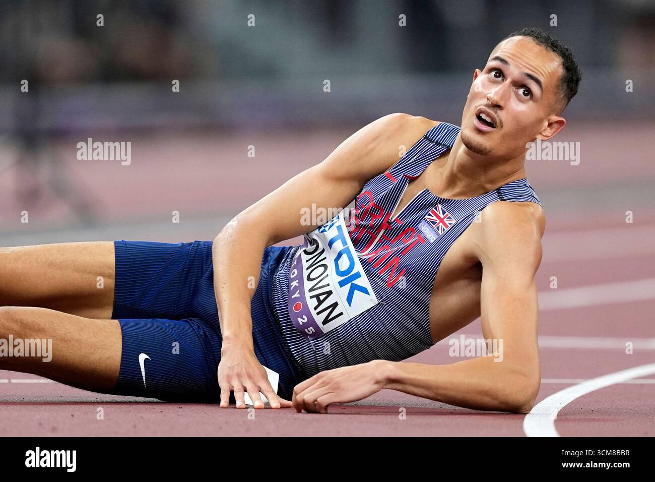 Britain's Tyri Donovan lays on the track after falling across the line in a men's 400 meters ...