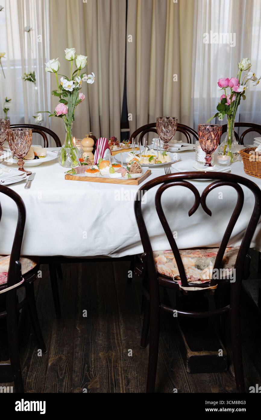 A stunning dining table features gourmet dishes, lovely flowers, and ...