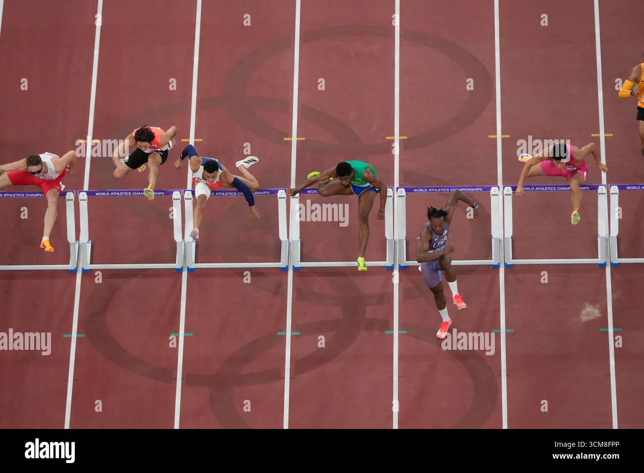 United States' Dylan Beard, bottom, clears a hurdle ahead of the field ...