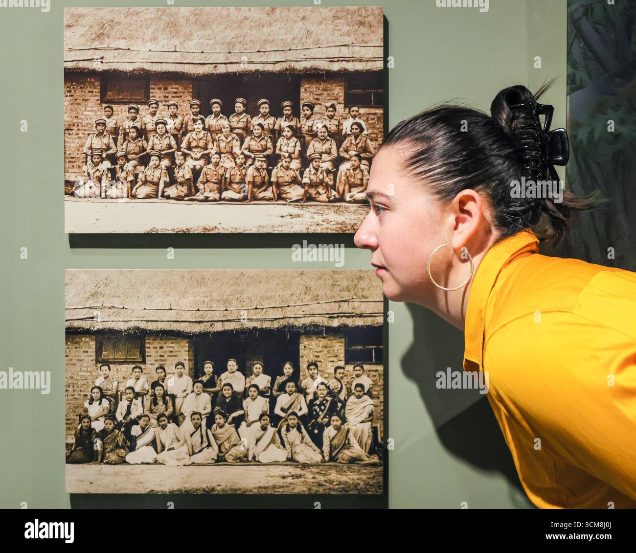London, UK, 15th Sep 2025. Exhibition staff with images showing members ...