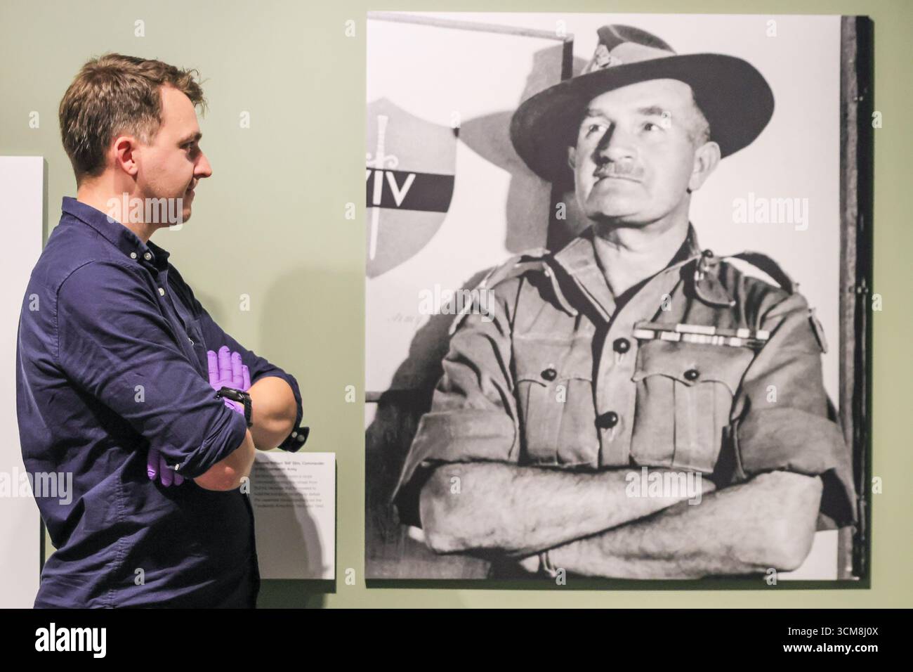 London, UK, 15th Sep 2025. Conservator Joshua Seymour a with a picture ...