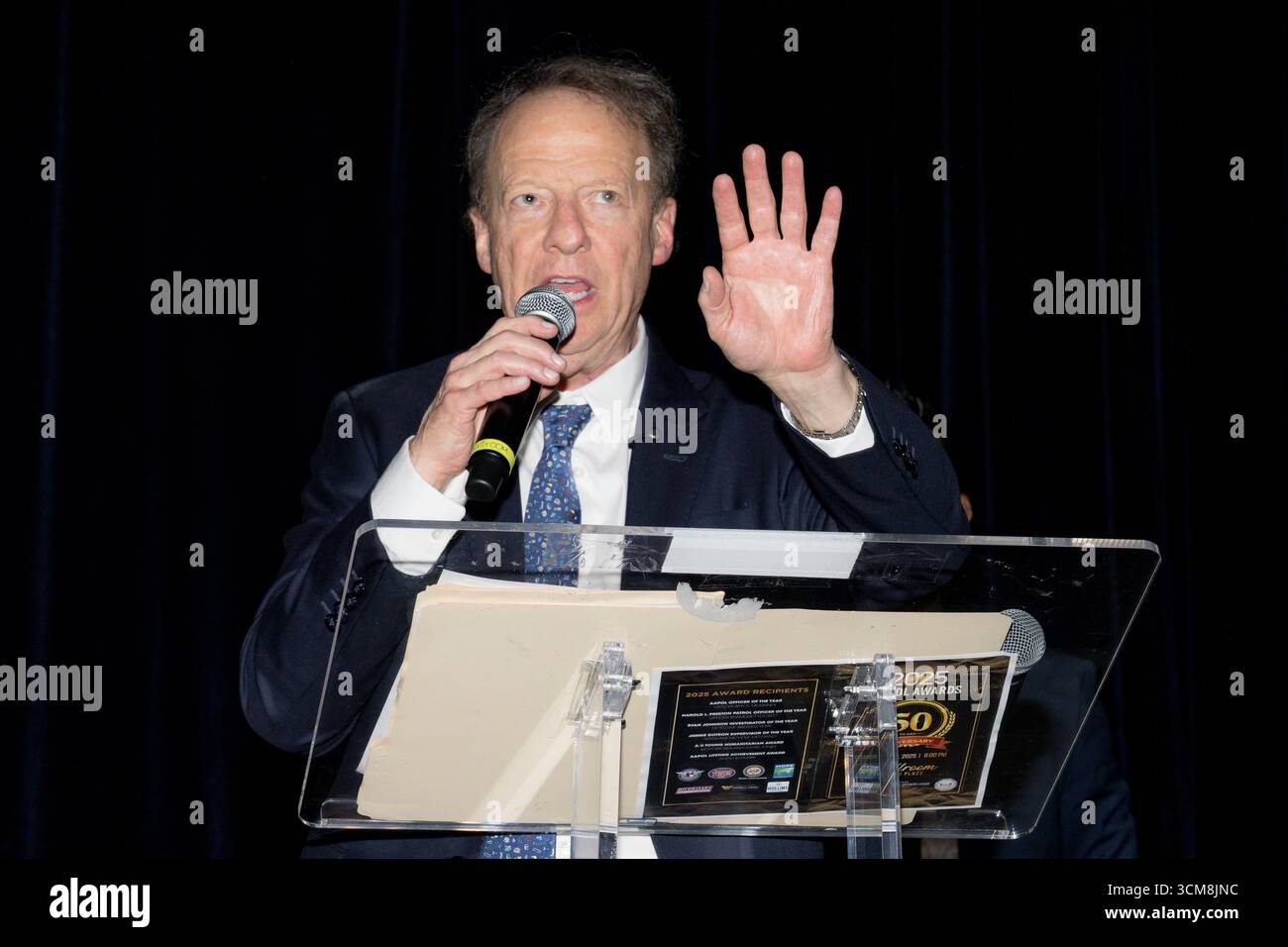 Alan Helfman speaks on stage during the 2025 AAPOL Awards dinner held ...