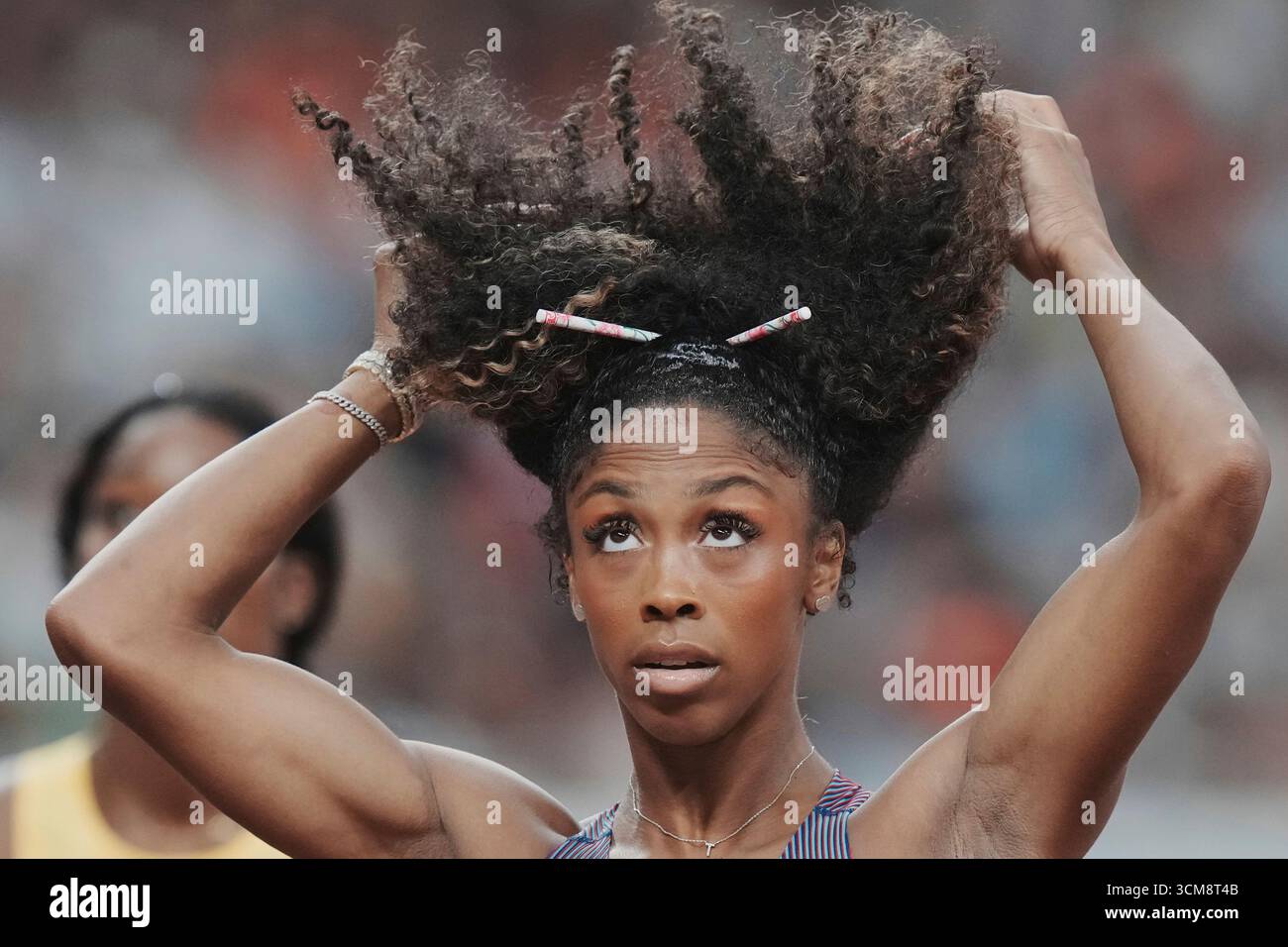 United States' Alaysha Johnson adjusts her hair as she prepares to ...