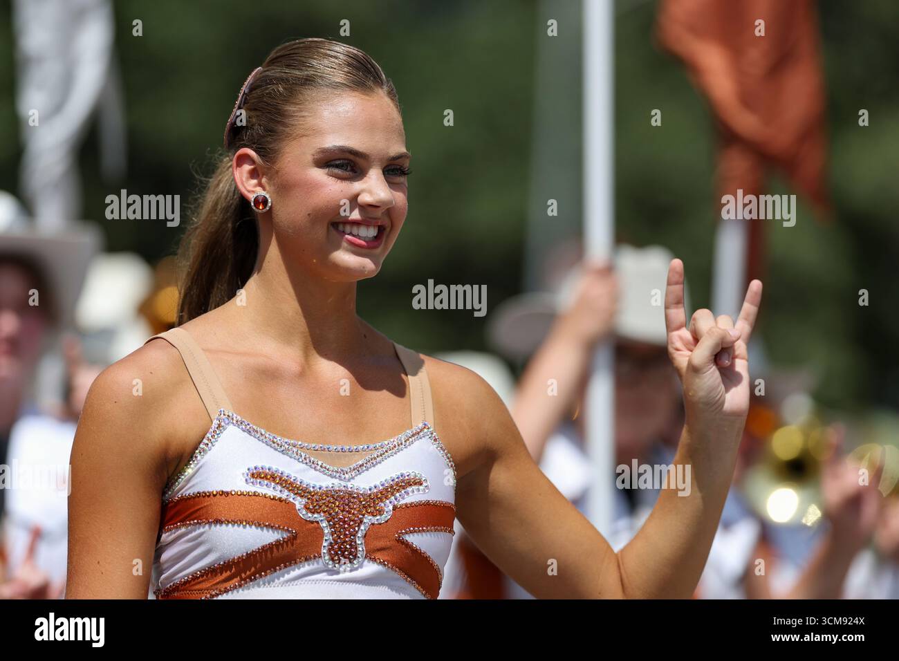 AUSTIN, TX - SEPTEMBER 13: Texas baton twirler Gracie Williams holds ...