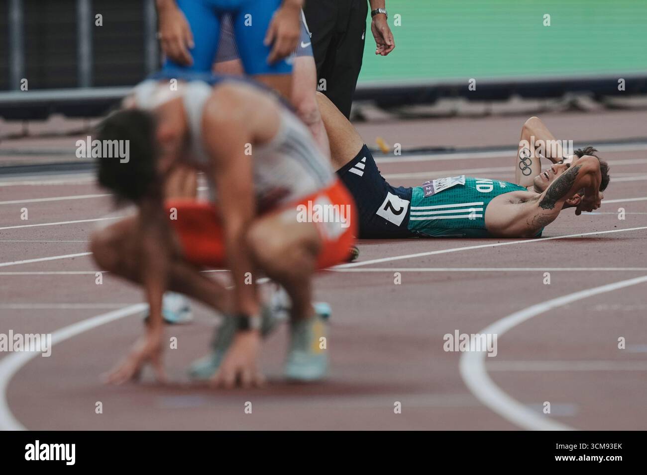 Ireland's Andrew Coscoran, right, reacts after competing in the men's ...