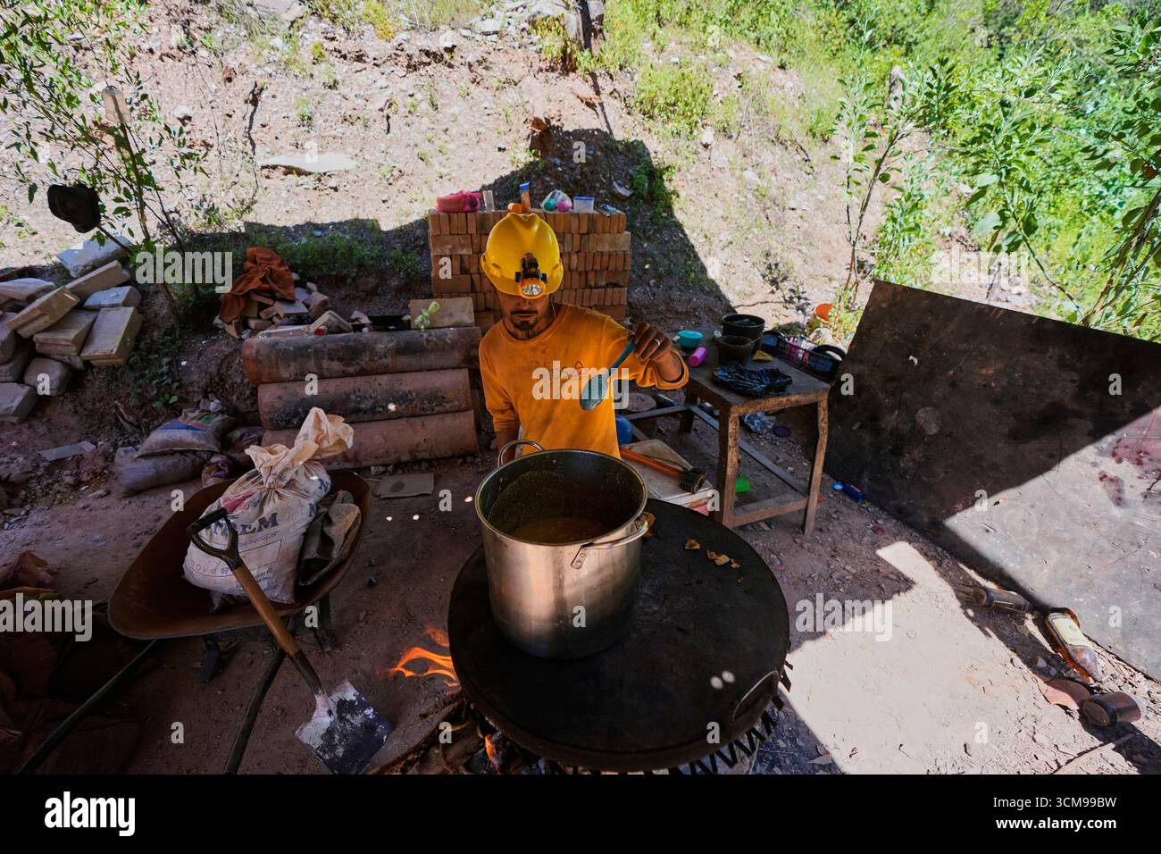 A miner heats food right next to the furnace where mercury is cooked in ...