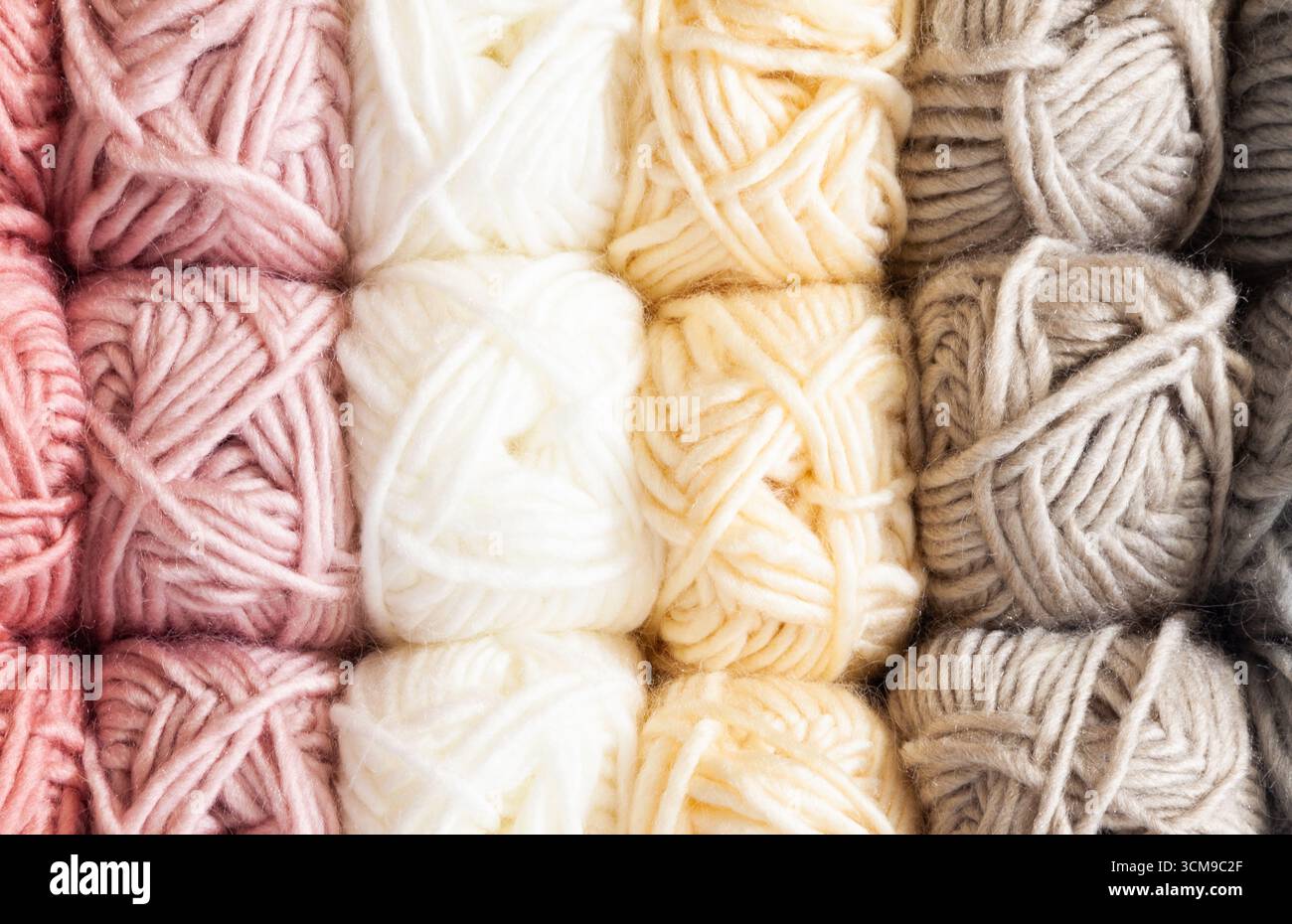 Clews of threads for knitting of different colors are stacked on the ...