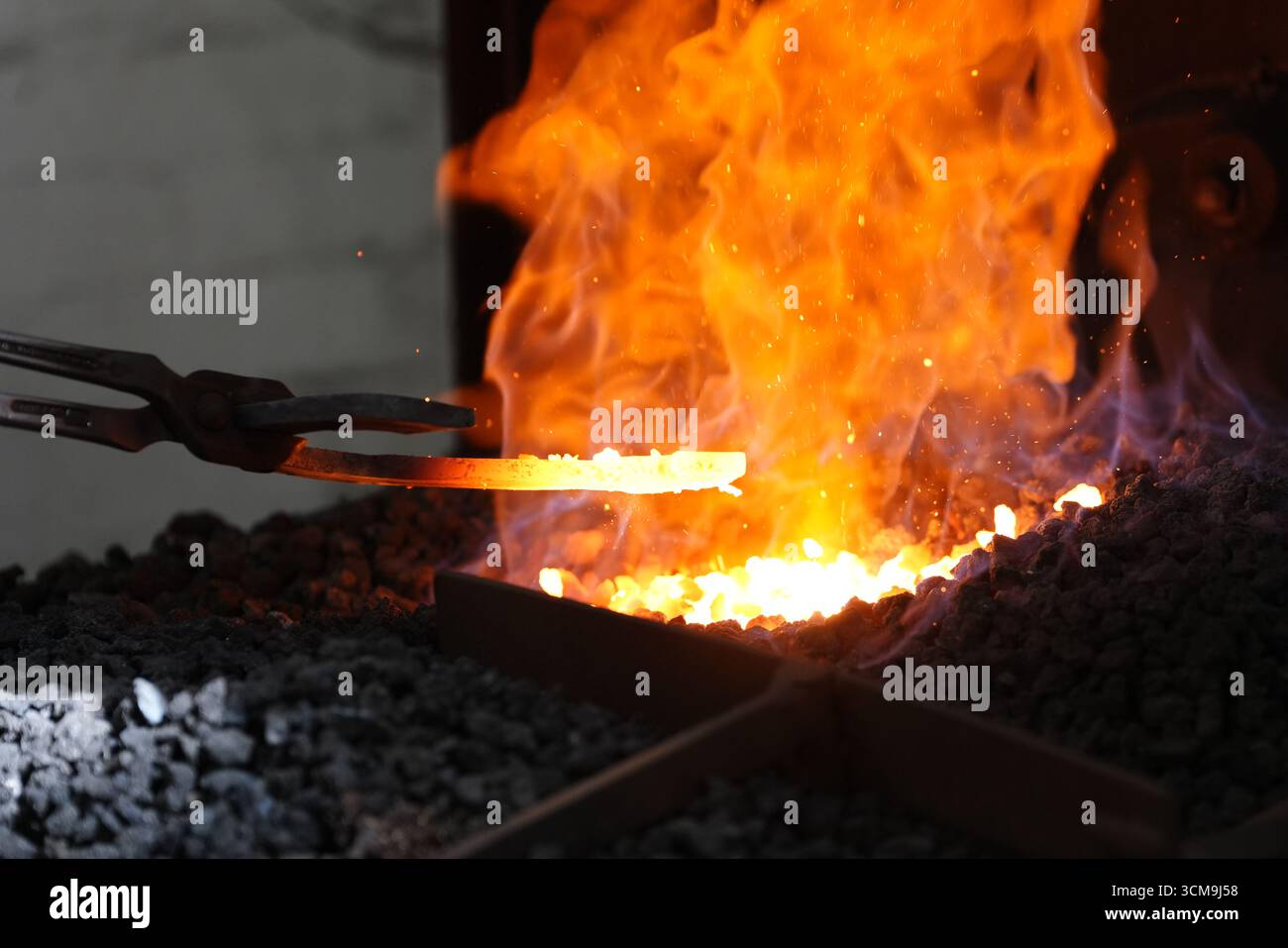 A British Army Farrier forges a horseshoe ahead of the State Visit of US President Donald Trump ...