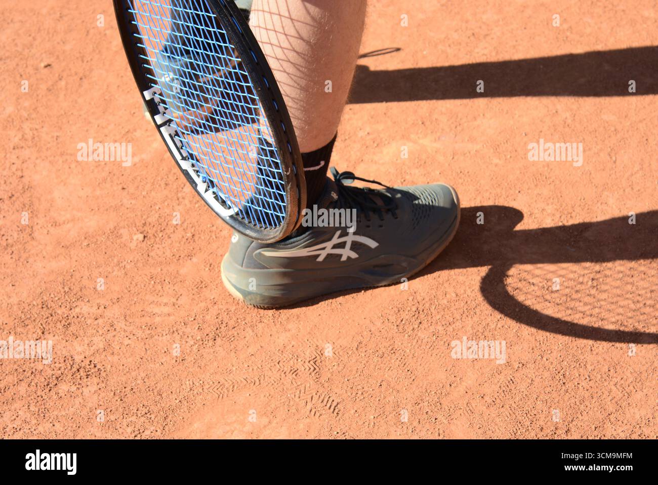 Athlete's tennis shoes worn from use with a racket on a court Stock ...