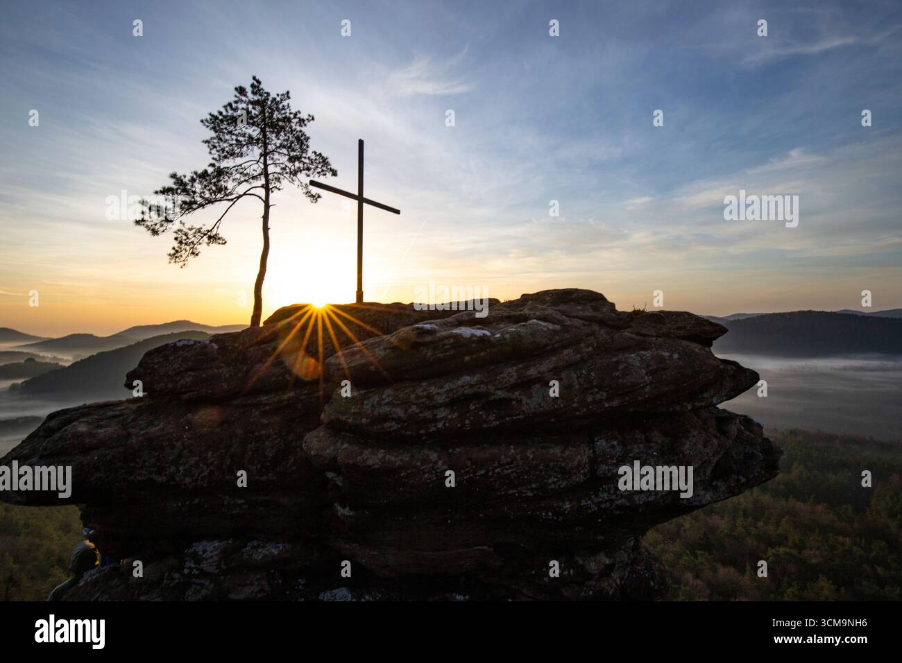Rising sun behind a sandstone cliff in the forest hi-res stock ...