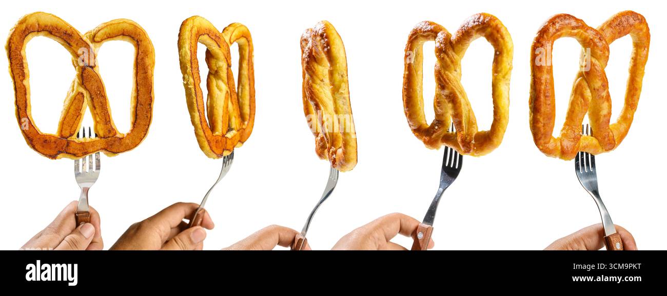 Collection set of human hands holding a salty baked brown pretzel with ...