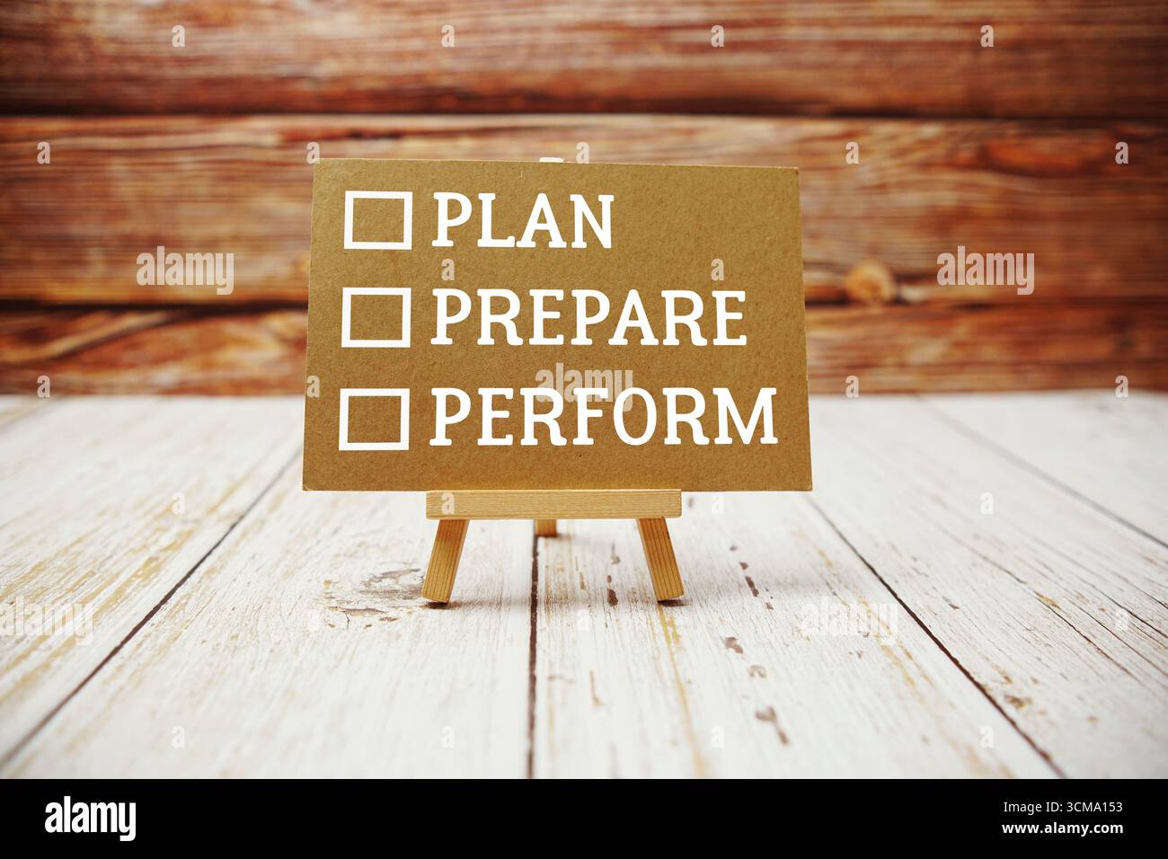 Plan, Prepare, Perform text message with easel on wooden background ...