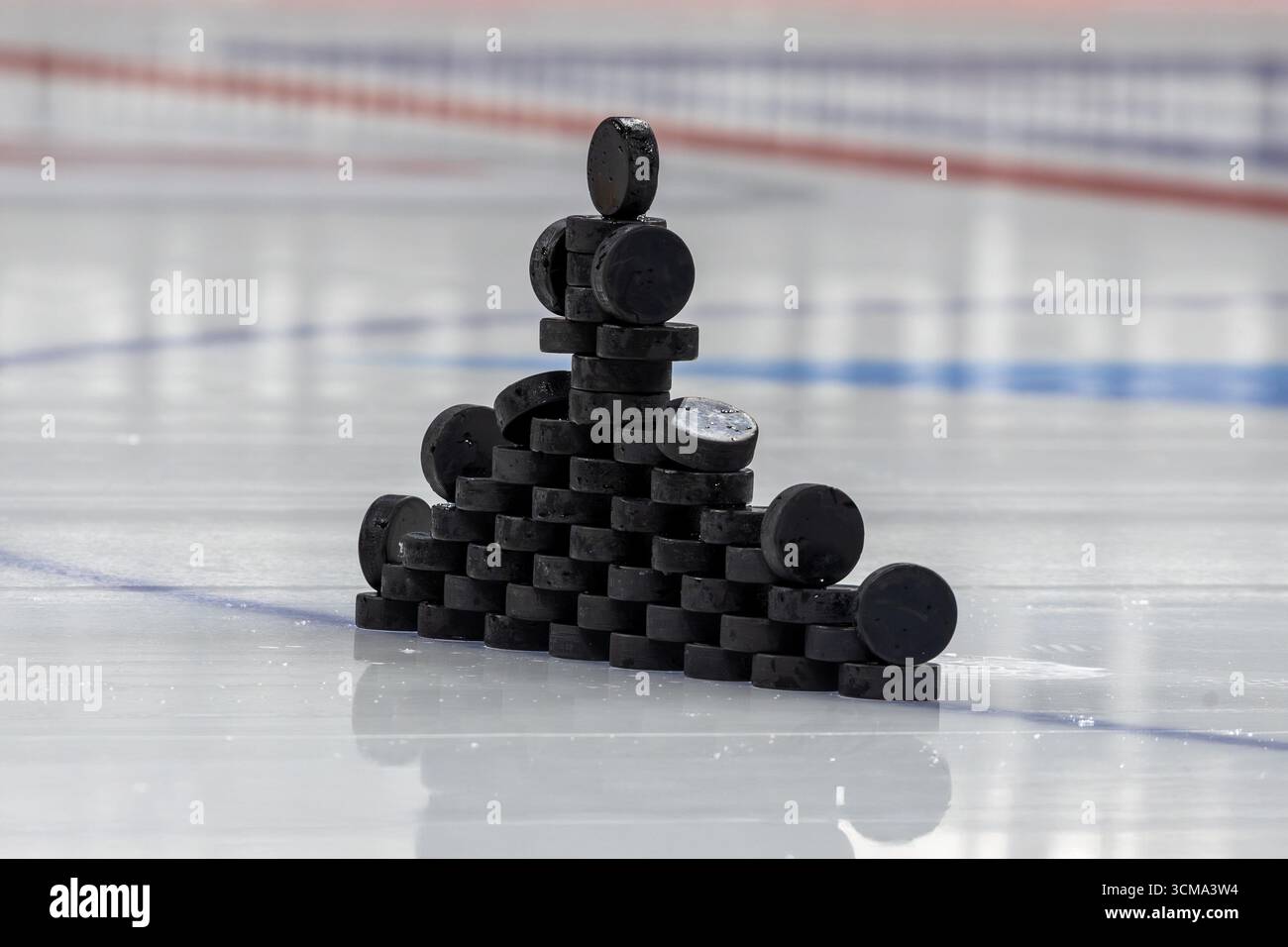Ice Hockey symbolic image: Close-up of pucks stacked on the ice for ...