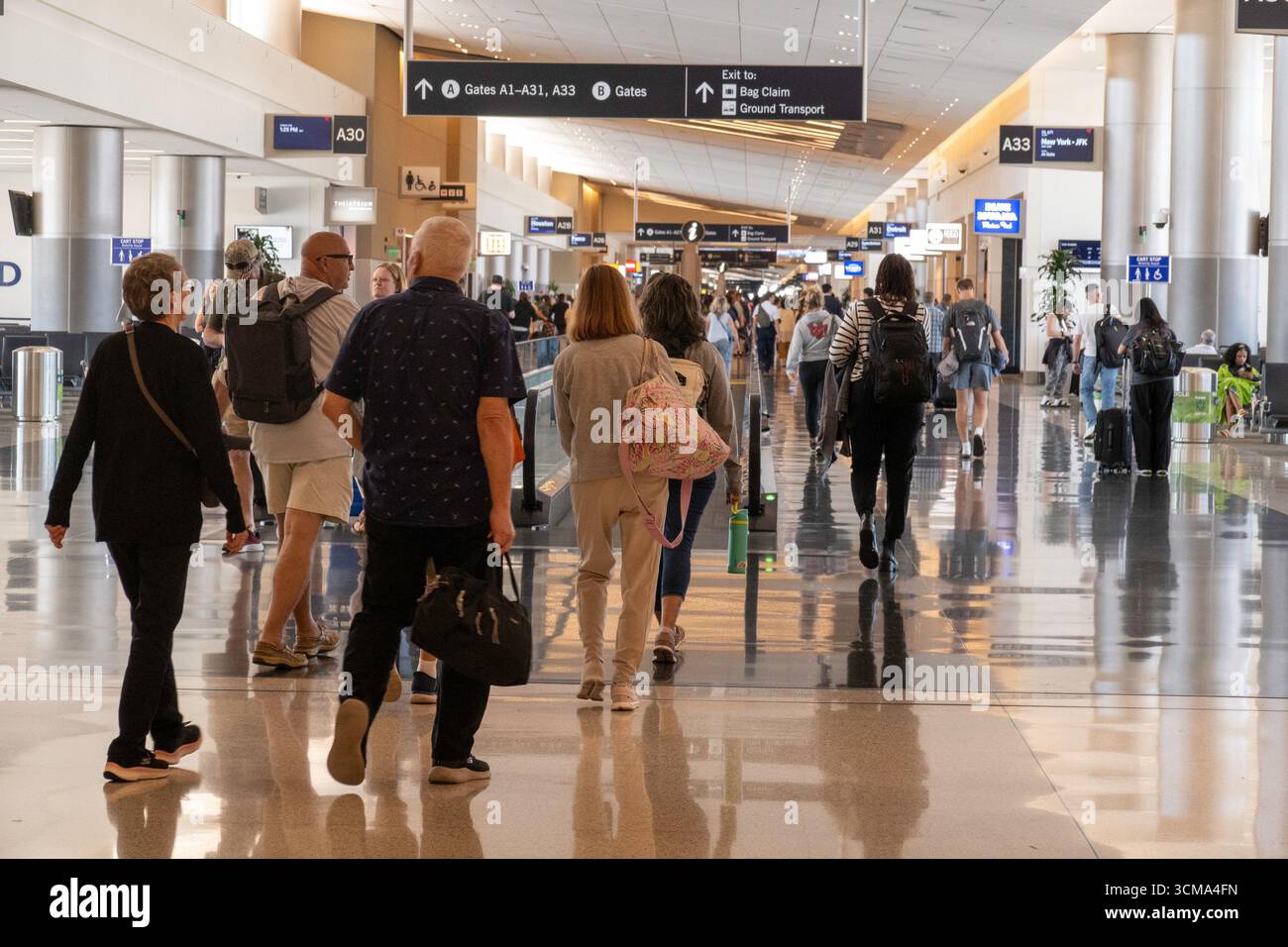 Salt Lake City International Airport terminal is very busy with ...