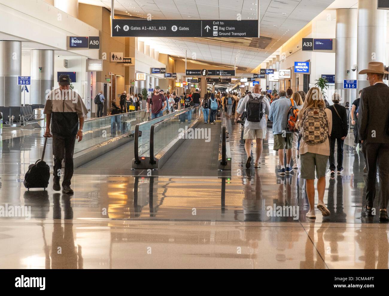 Salt Lake City International Airport terminal is very busy with ...