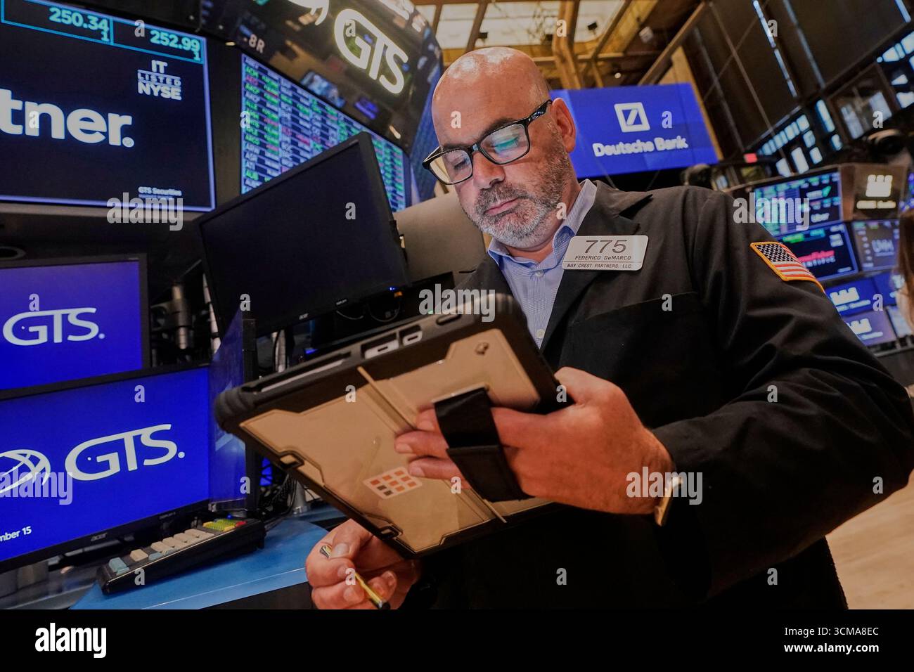 Trader Fred Demarco works on the floor of the New York Stock Exchange ...