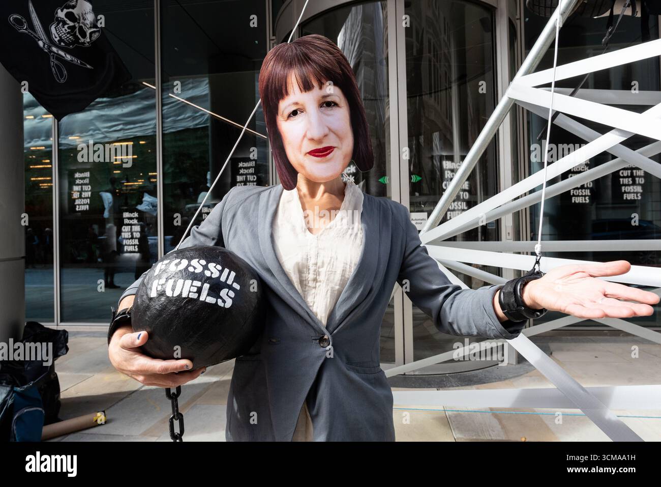 London, UK. 15 September, 2025. An activist in a mask depicts ...