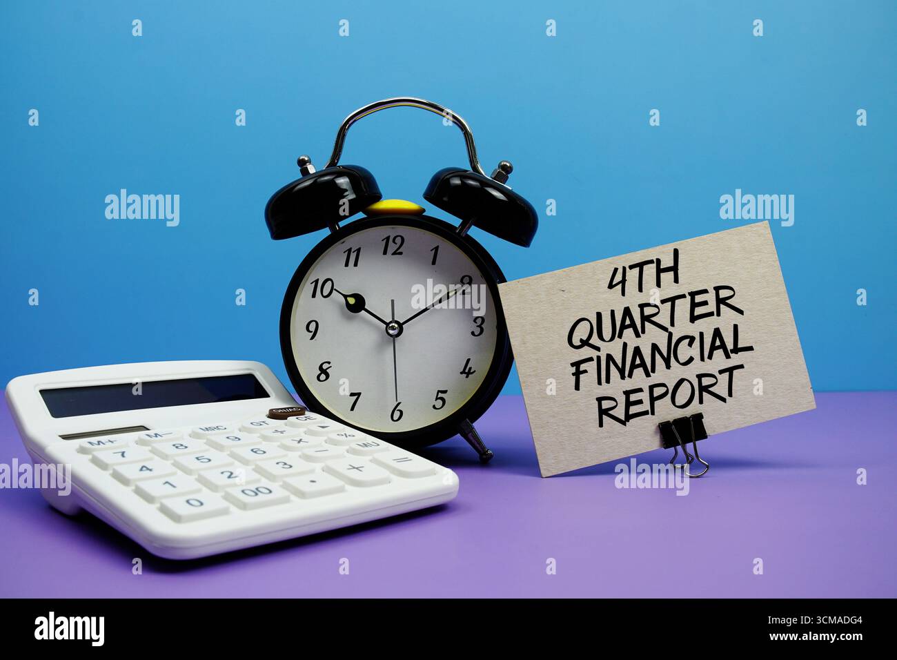4th Quarter Financial Report text with calculator and alarm clock on ...