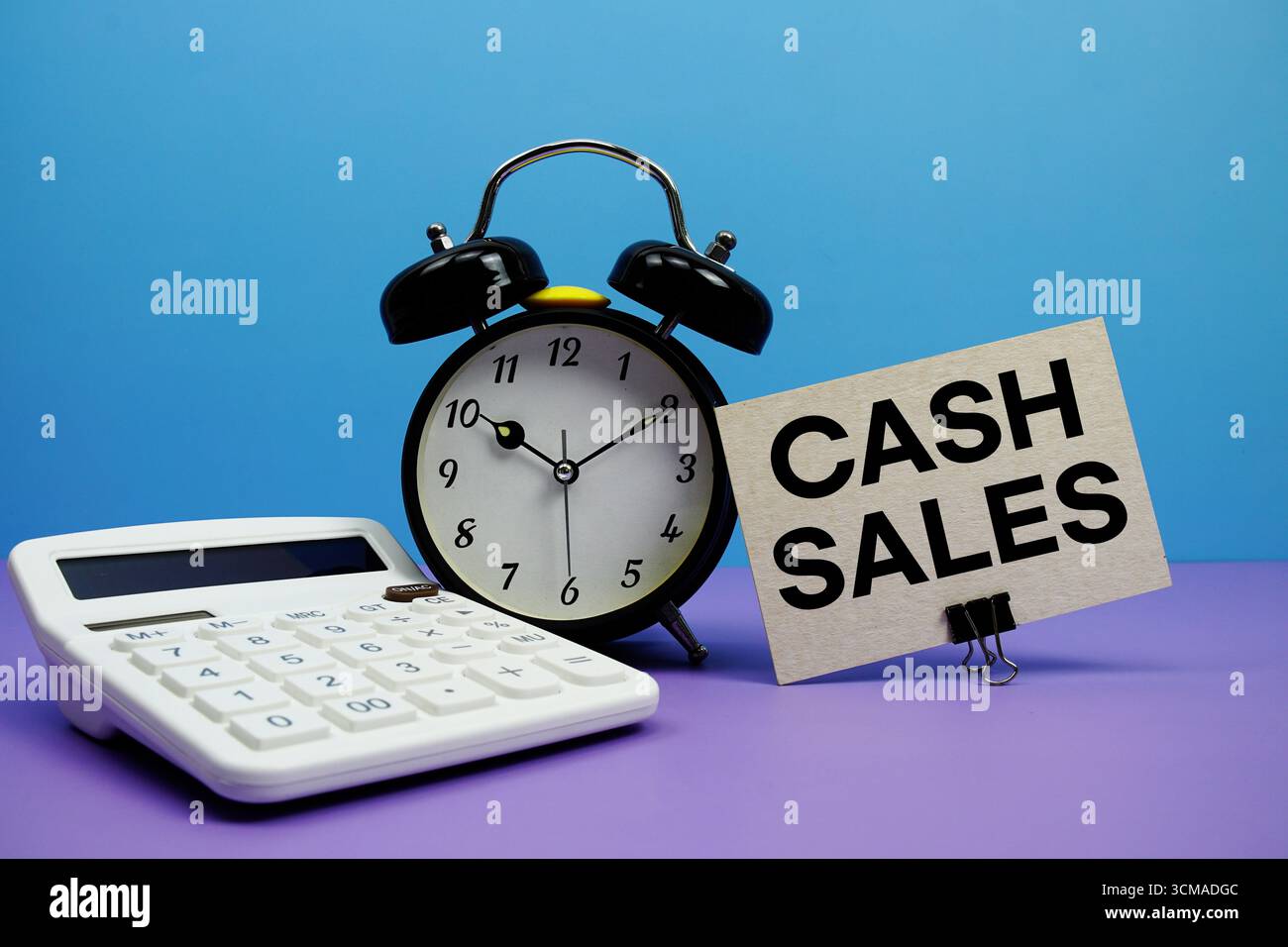 Cash Sales text with calculator and alarm clock on blue and purple ...
