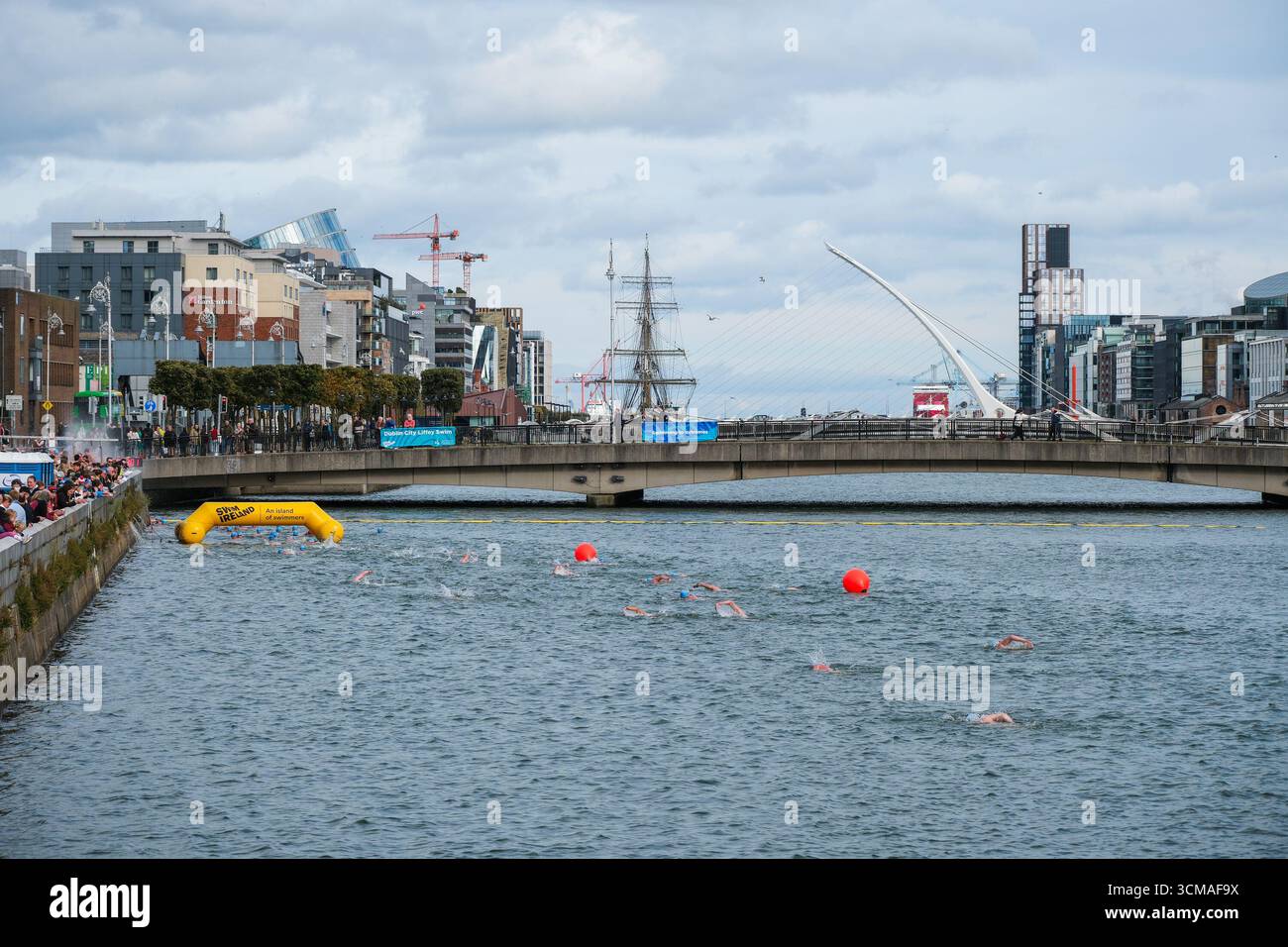 Swimmers arriving to the finish line with Samuel Backett Bridge and The ...