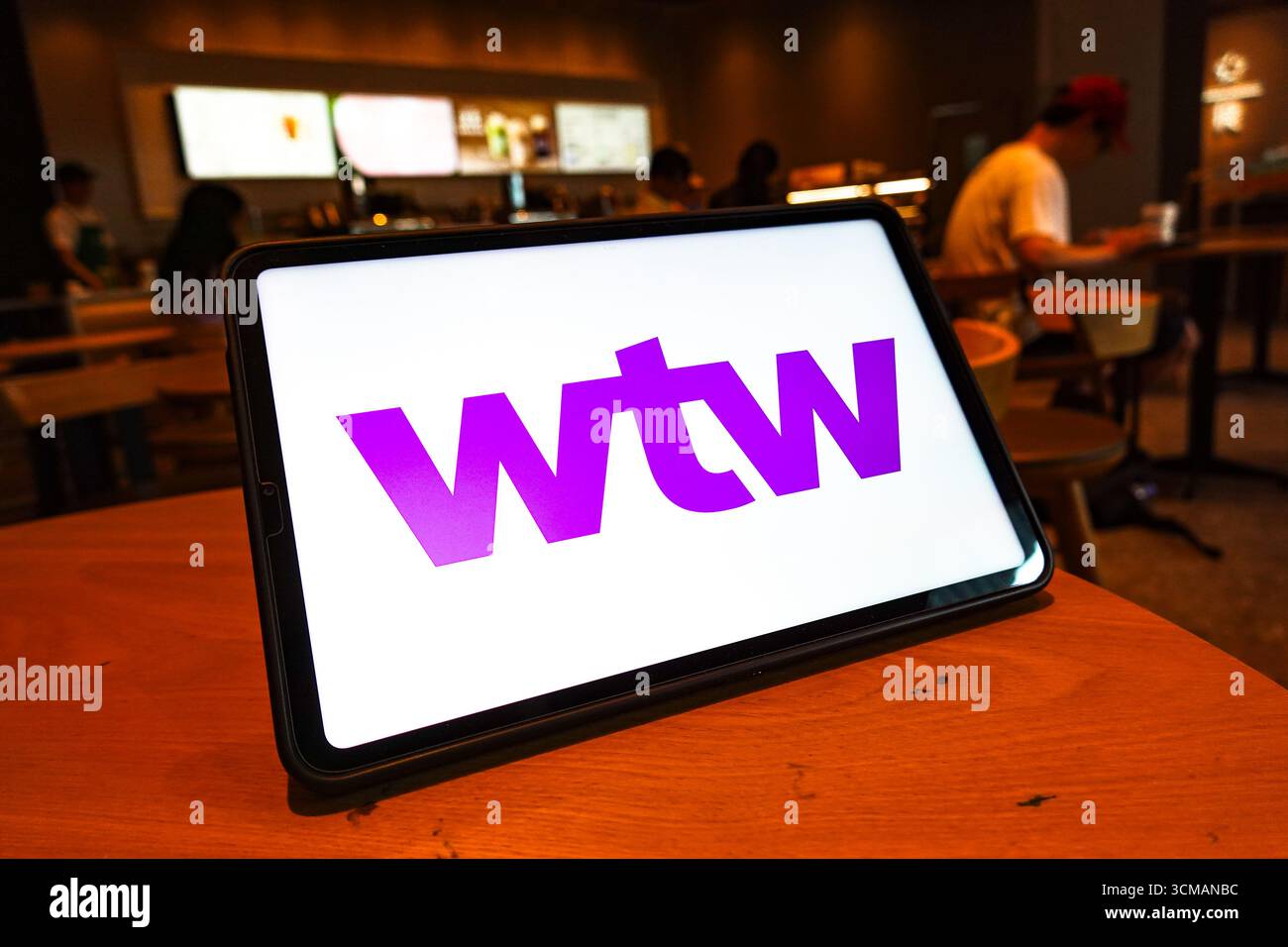 In this photo illustration, the logo of WTW is displayed on the screen ...