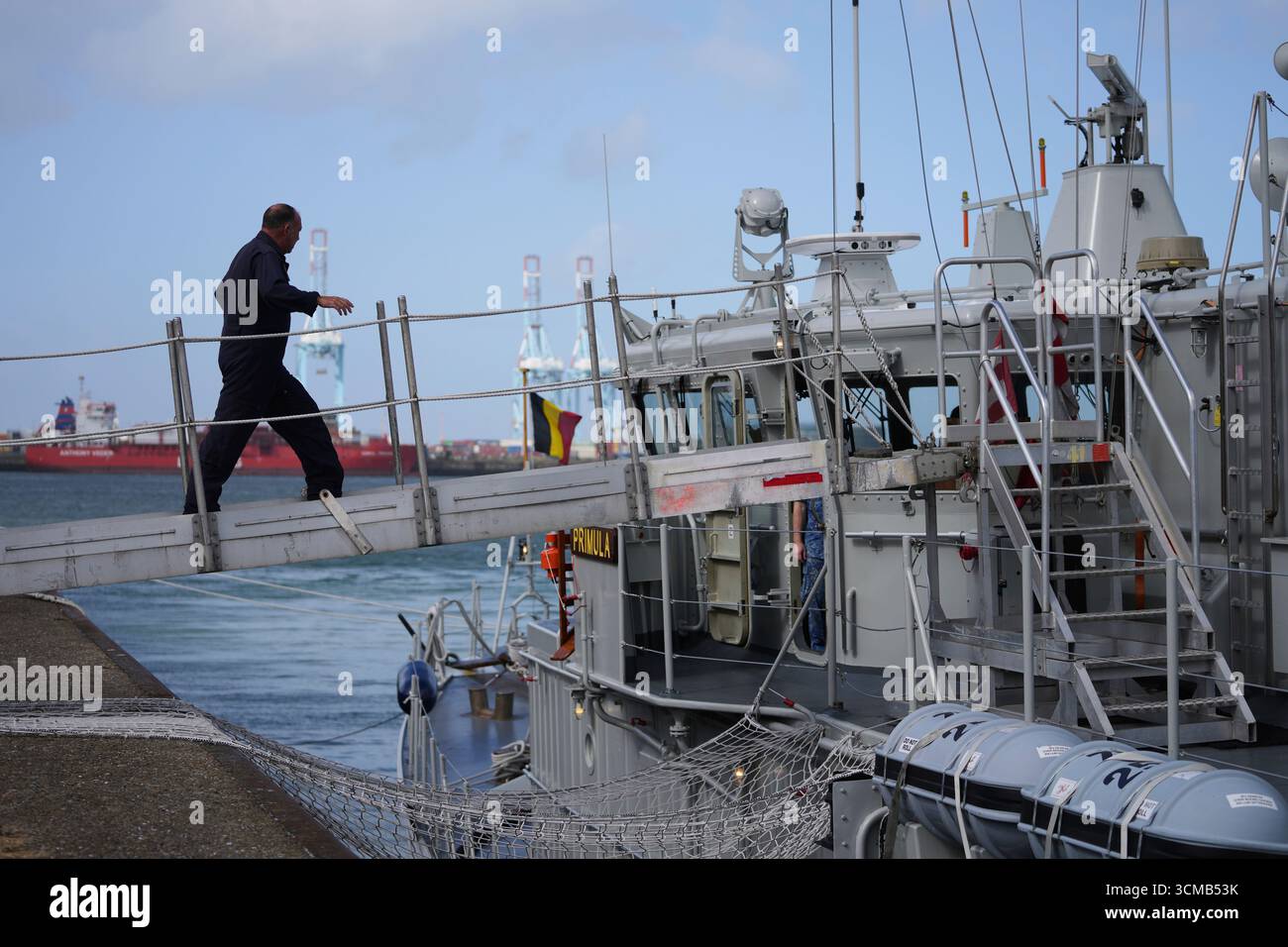 A crew member boards the Belgian Navy ship Primula as it is docked in ...