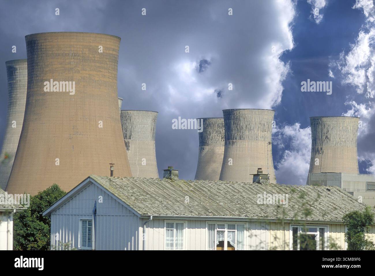 Cooling towers of a coal-fired power station next to a residential ...