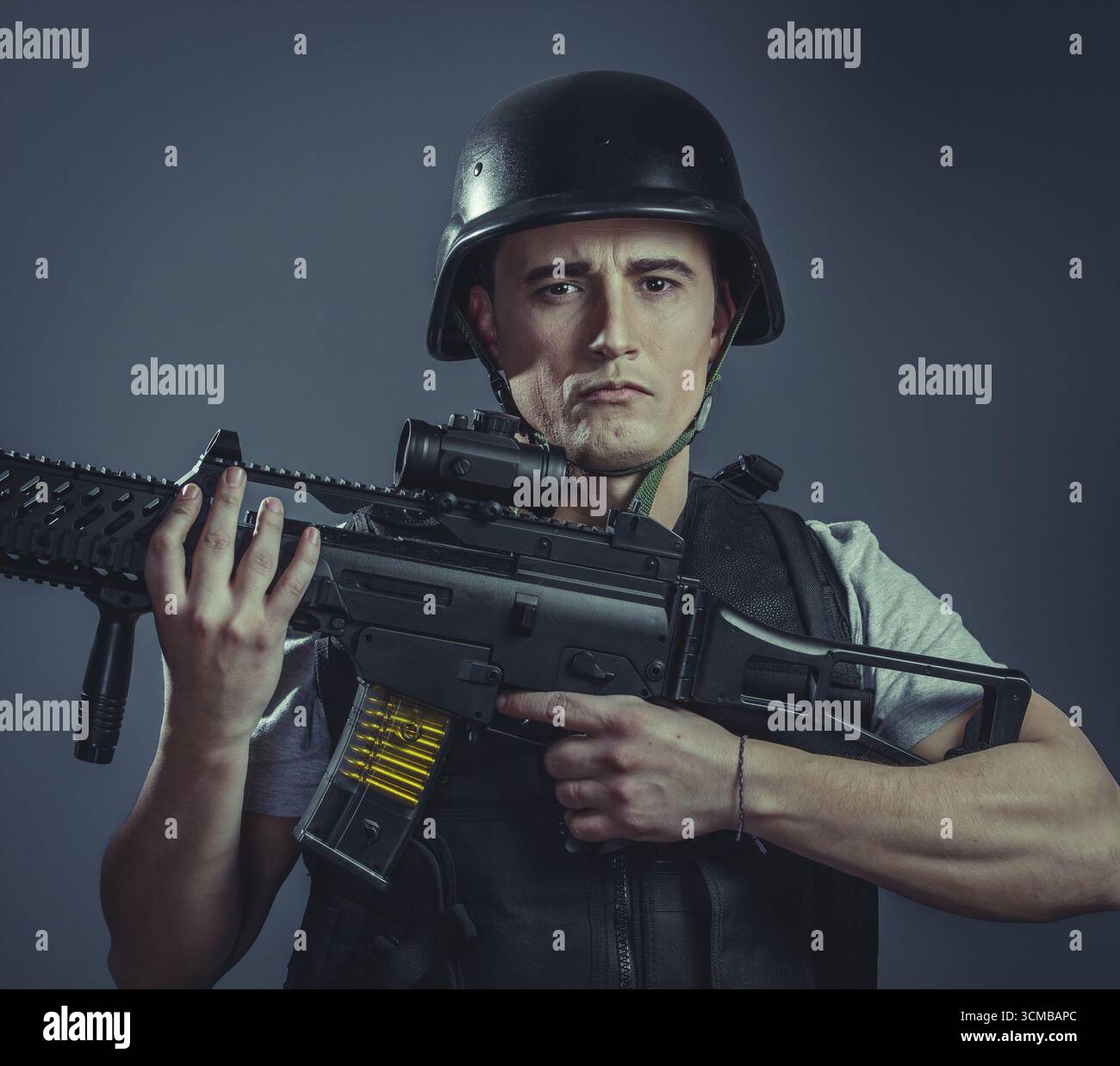 Recreation, paintball sport player wearing protective helmet aiming ...