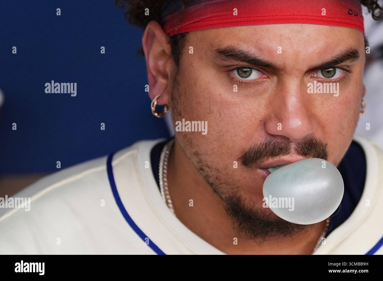 Seattle Mariners first baseman Josh Naylor blows a bubble in the dugout ...