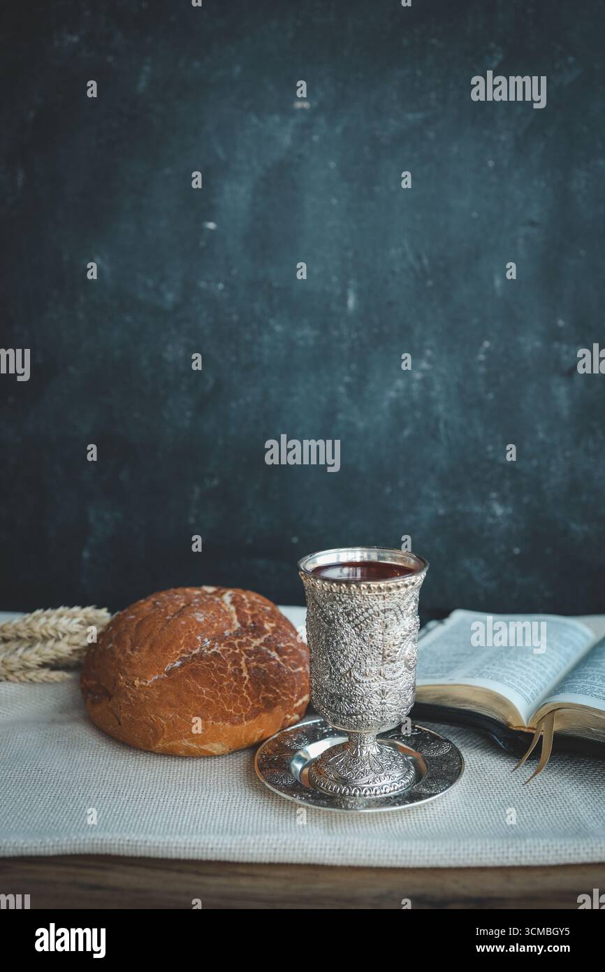 Wine, bread and open bible, communion concept Stock Photo - Alamy