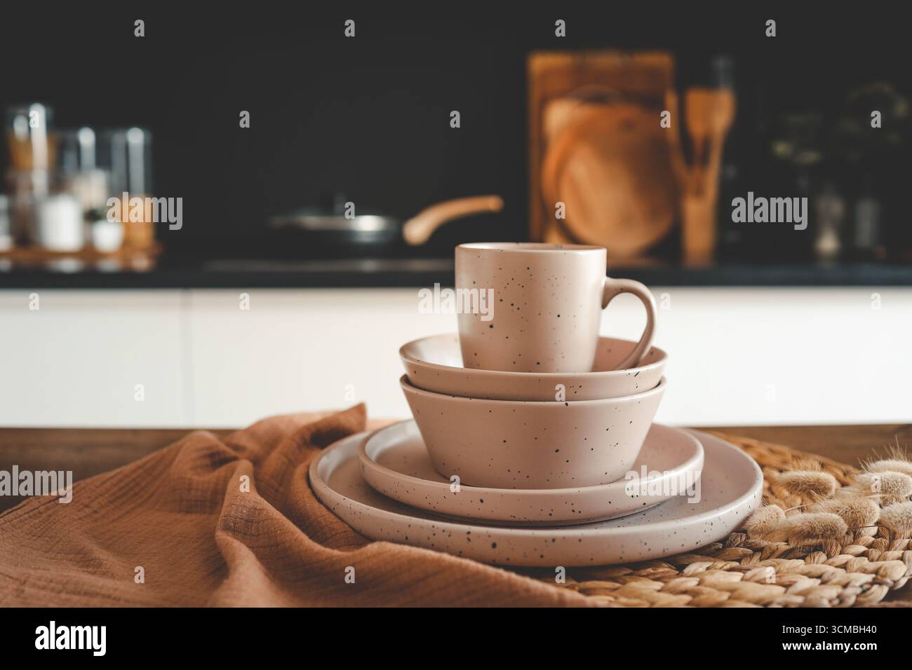 Set of beige minimalist dishes on a table against the backdrop of a ...