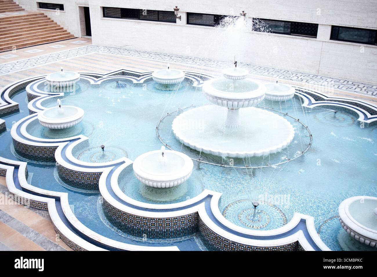 Elegant multi-tiered fountain features intricate tile patterns and ...