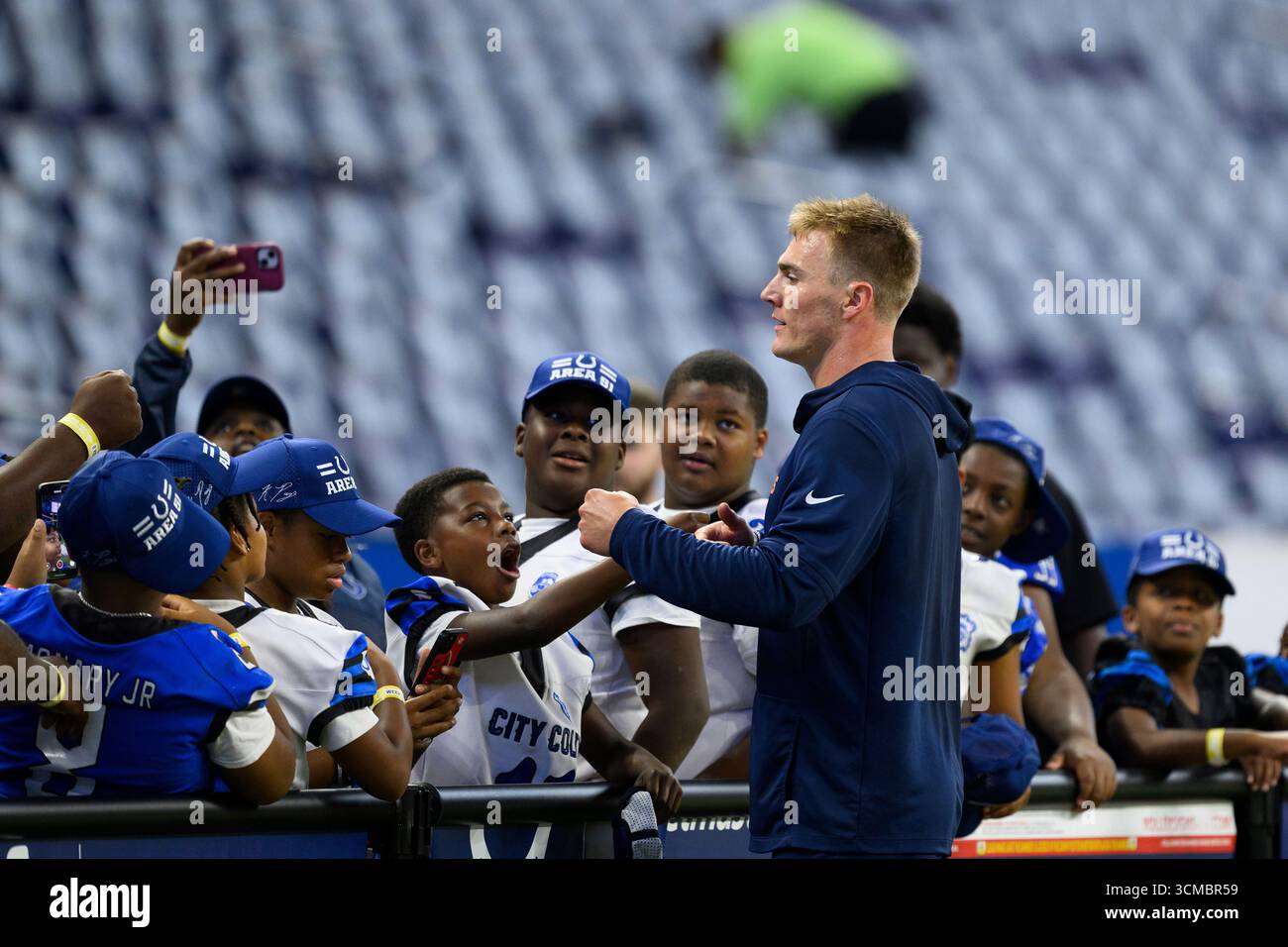 Denver Broncos quarterback Bo Nix (10) takes a photo with a group of ...