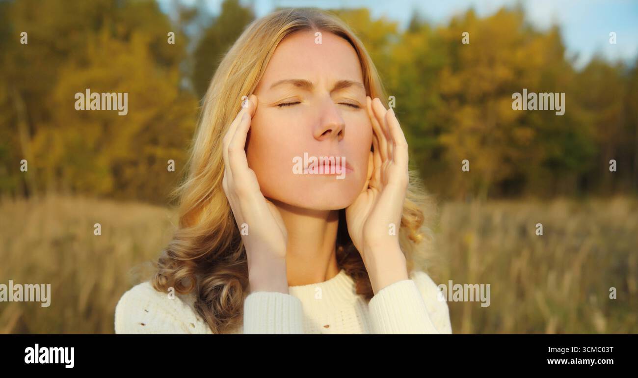 Upset exhausted young woman with headache, pain tension in the head ...