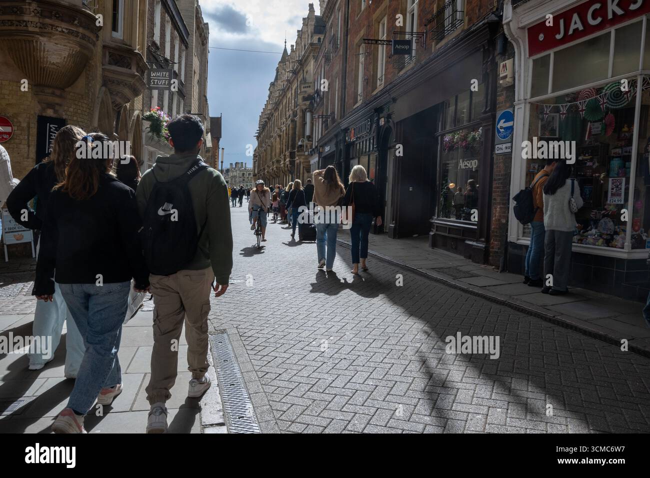 Busy street scene in Cambridge city centre with people walking past ...