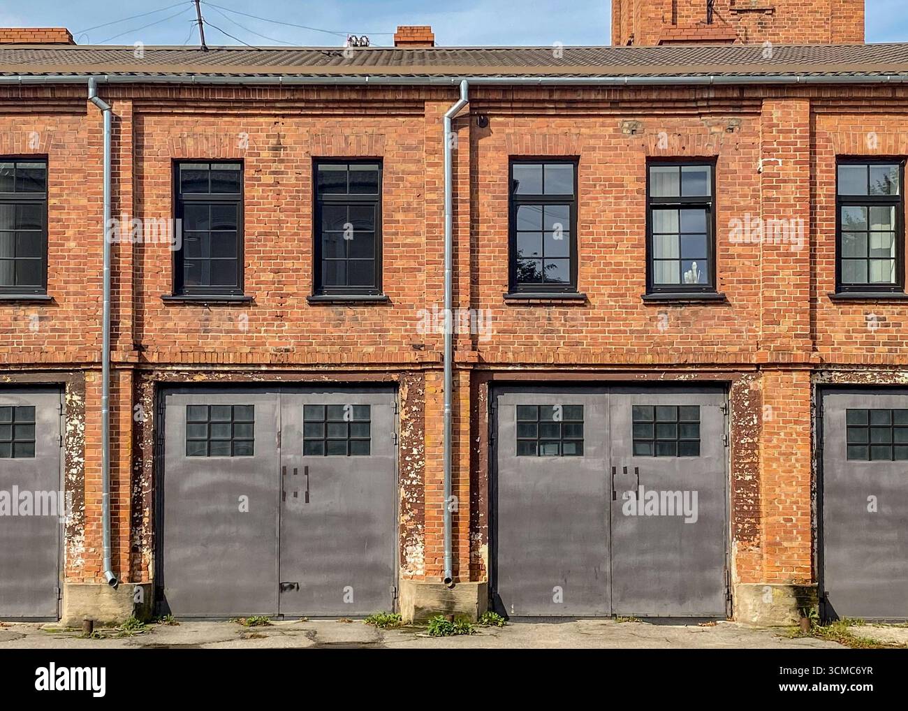 Old commercial building hangar with tower. Town fire station ...
