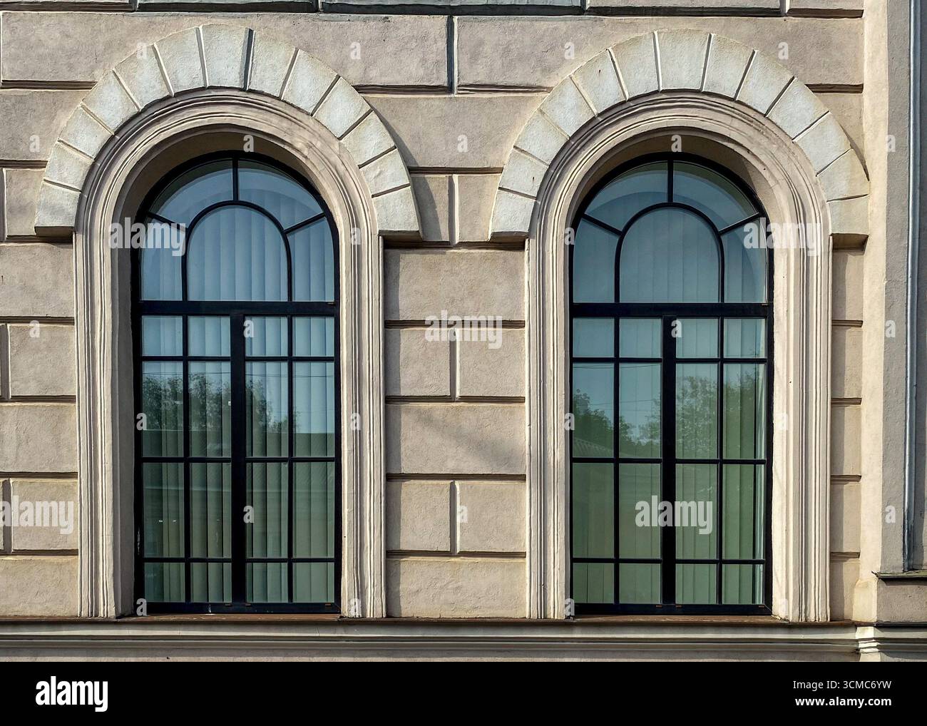 Ornate large arched windows. Great decorated historic building facade ...