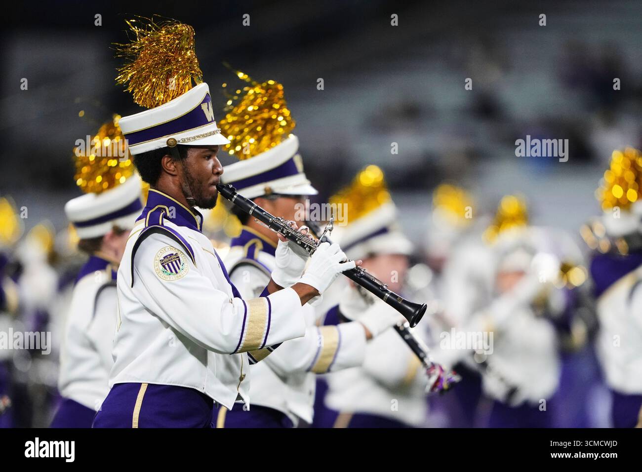 The Husky Marching Band performs before an NCAA college football game ...
