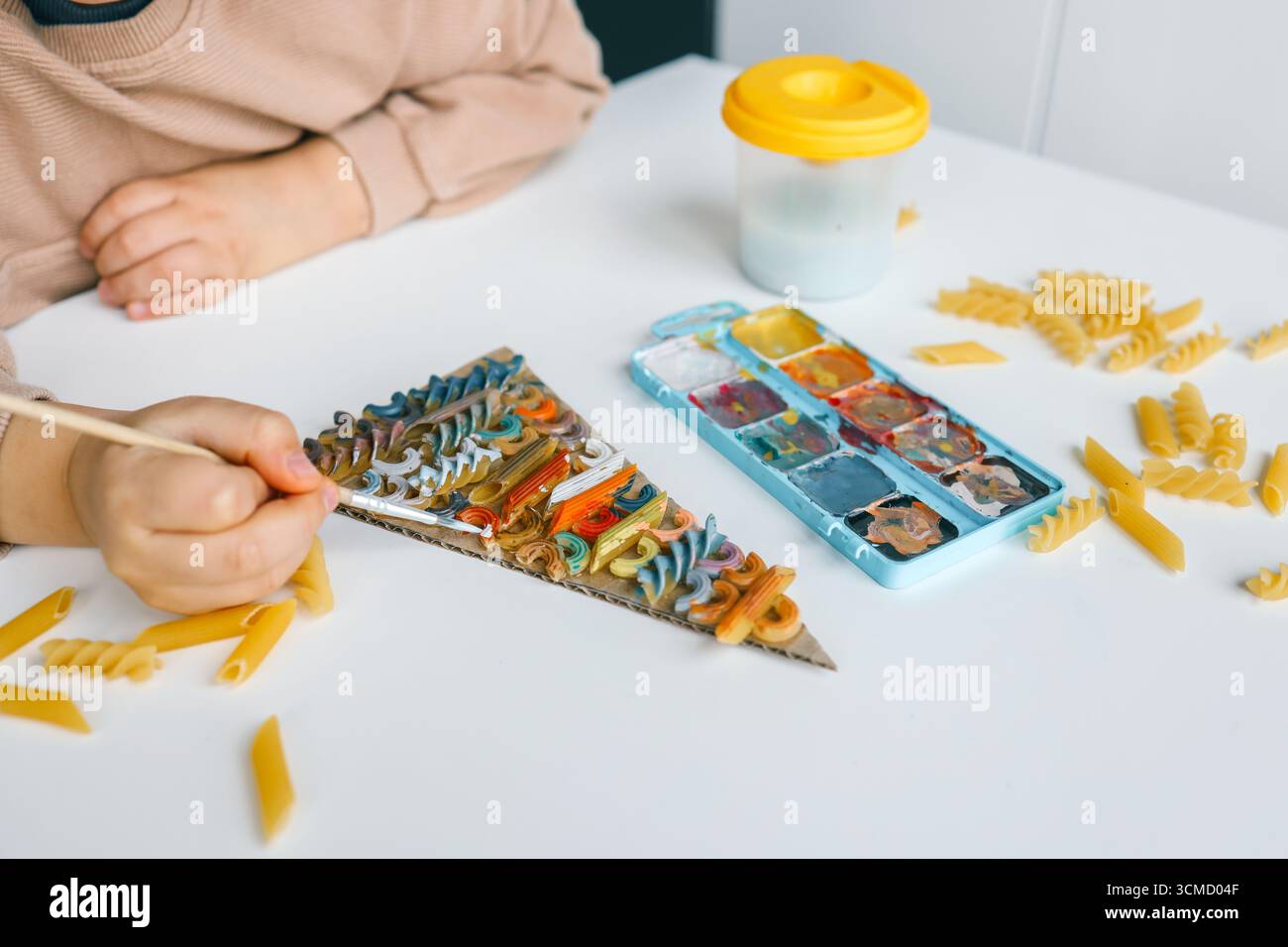 Sensory creative activity for children, child coloring pasta Stock ...