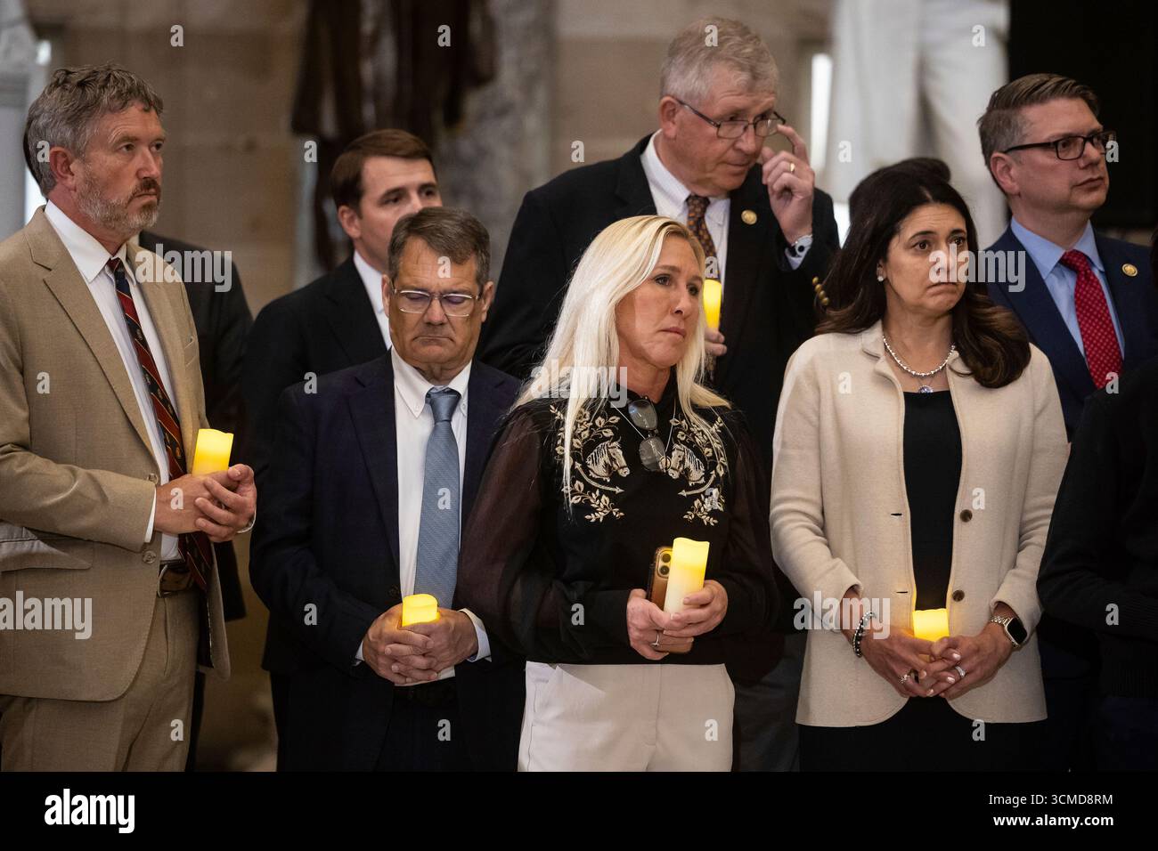 Rep. Marjorie Taylor Greene (R-Ga.), center, stands with other members ...