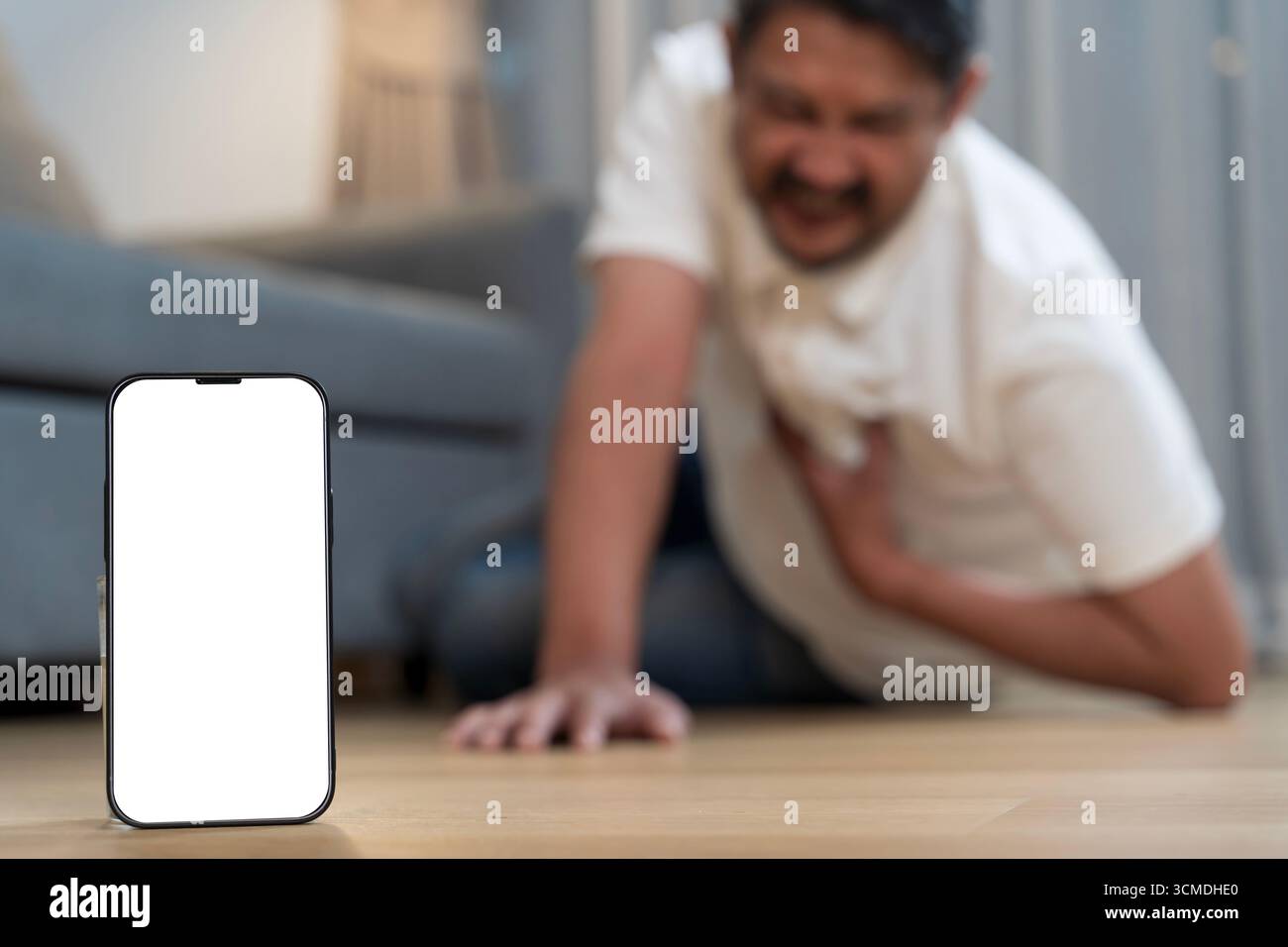 Smartphone with blank screen in focus while a man in the background ...