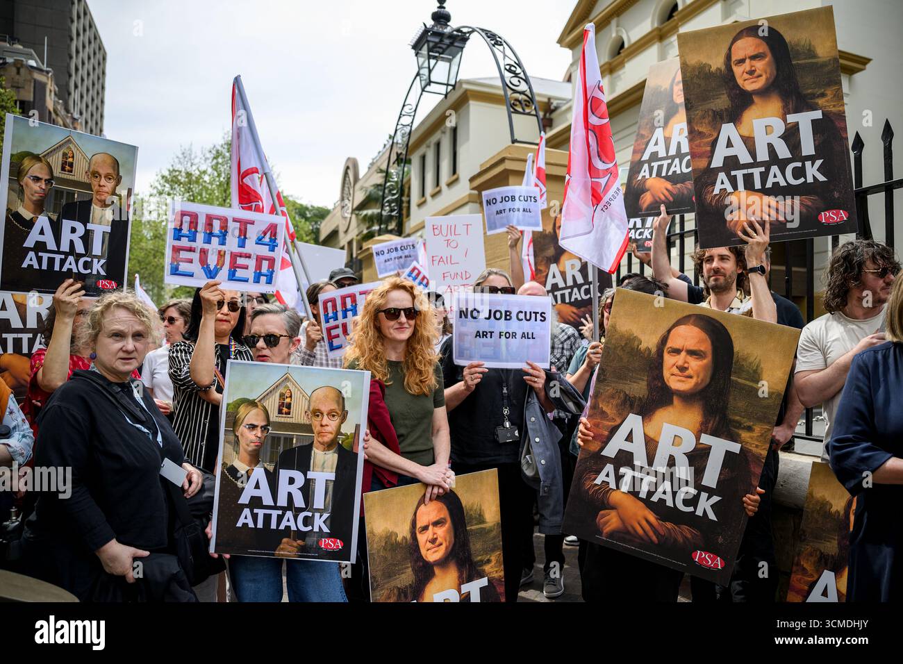 Art Gallery Of NSW (AGNSW) staff hold placards depicting NSW Minister ...