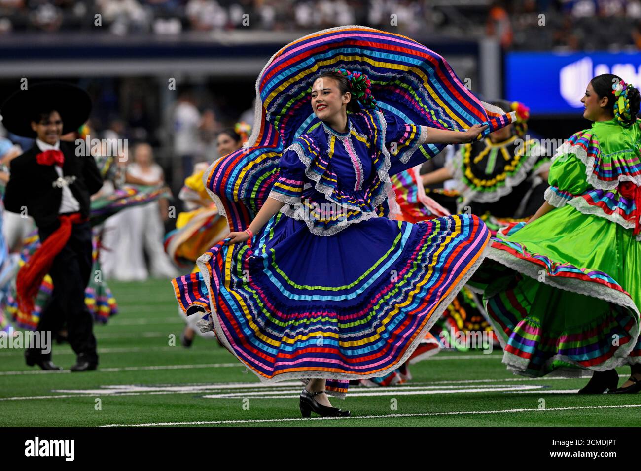 Folklorico dancers perform at halftime of a football game as the NFL ...