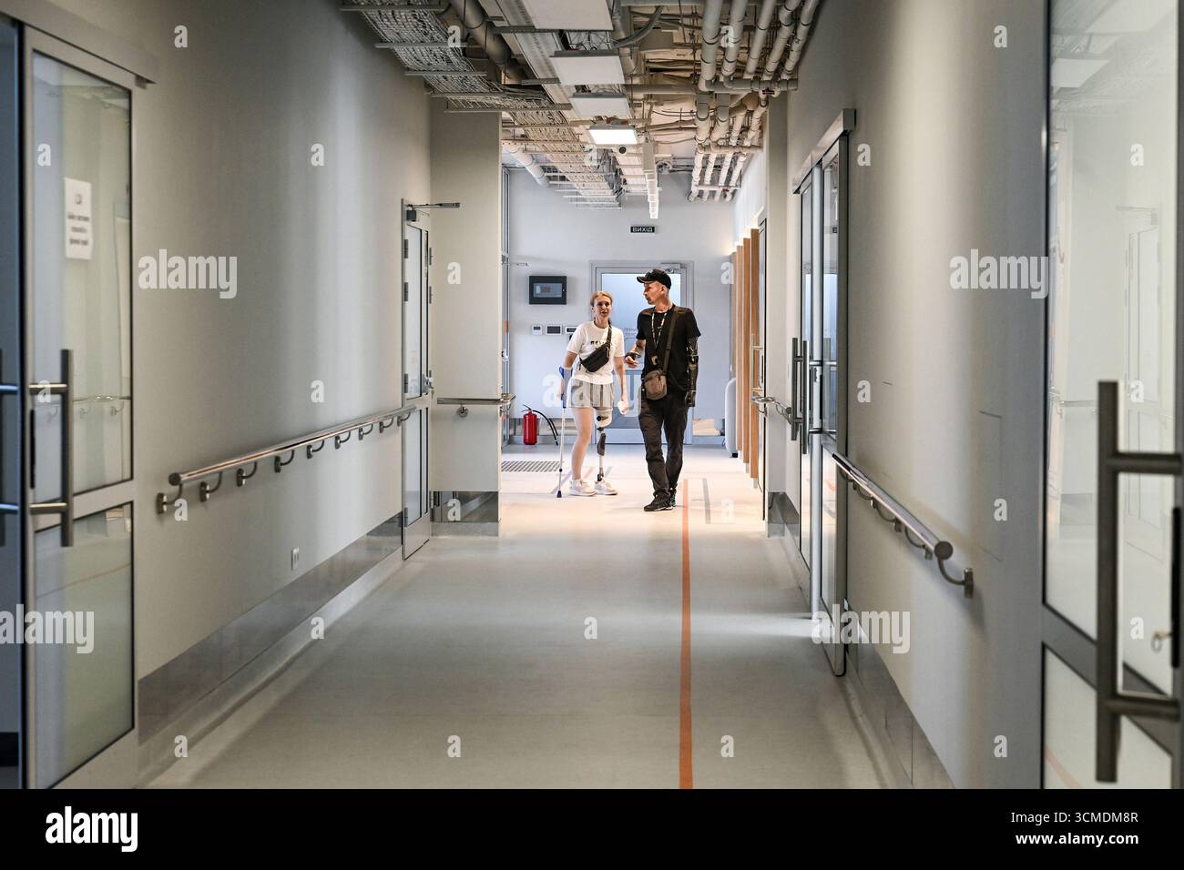 Non Exclusive: Patients with prosthetic limbs walk through the corridor ...