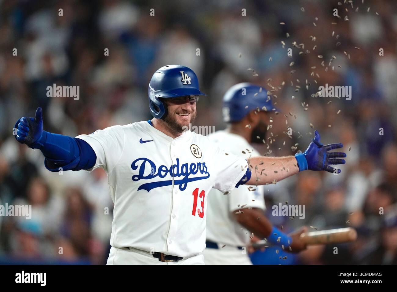 Los Angeles Dodgers' Max Muncy has seeds thrown at him after hitting a ...